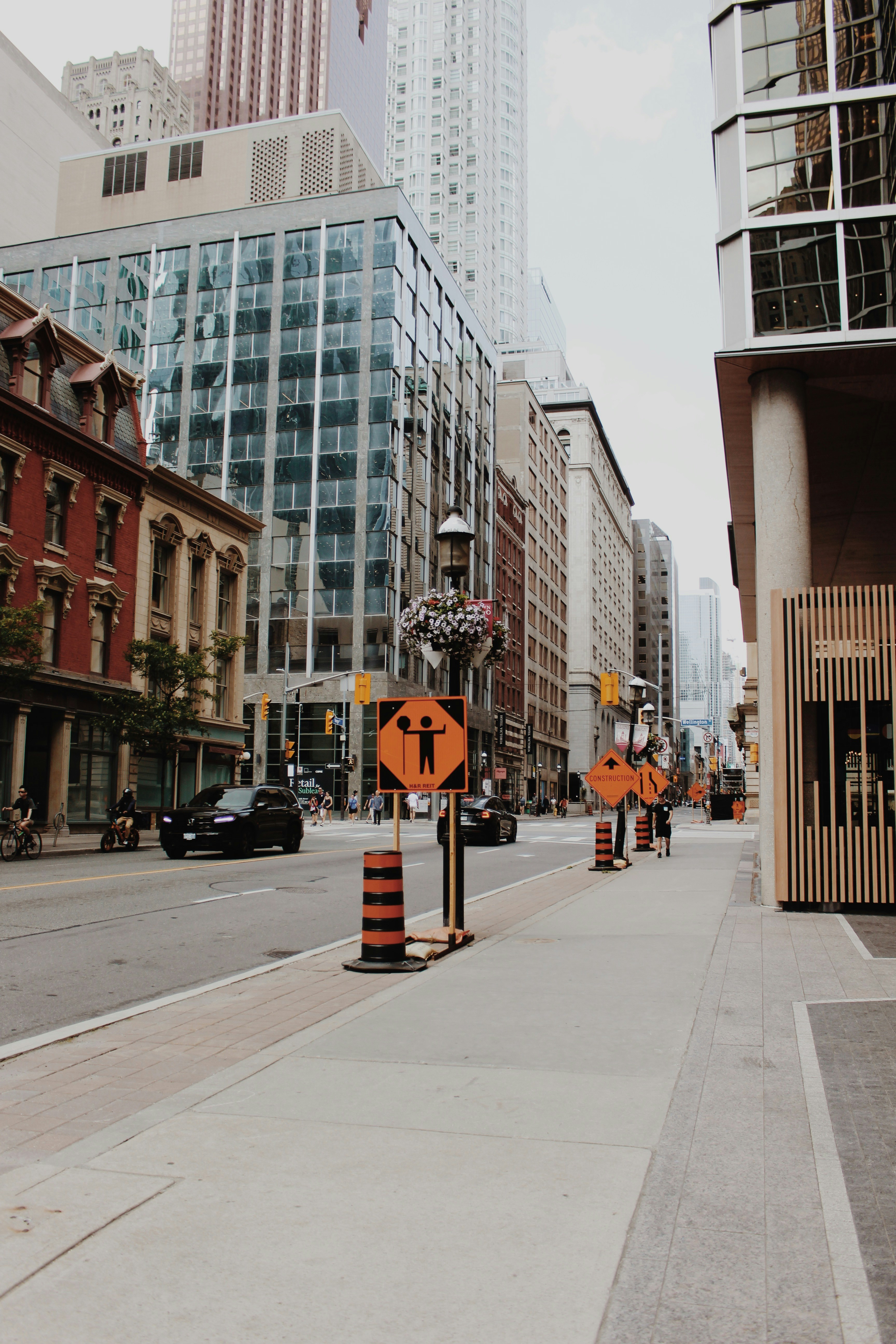City Street in Flux: Construction Signs and Tall Glass Facades
