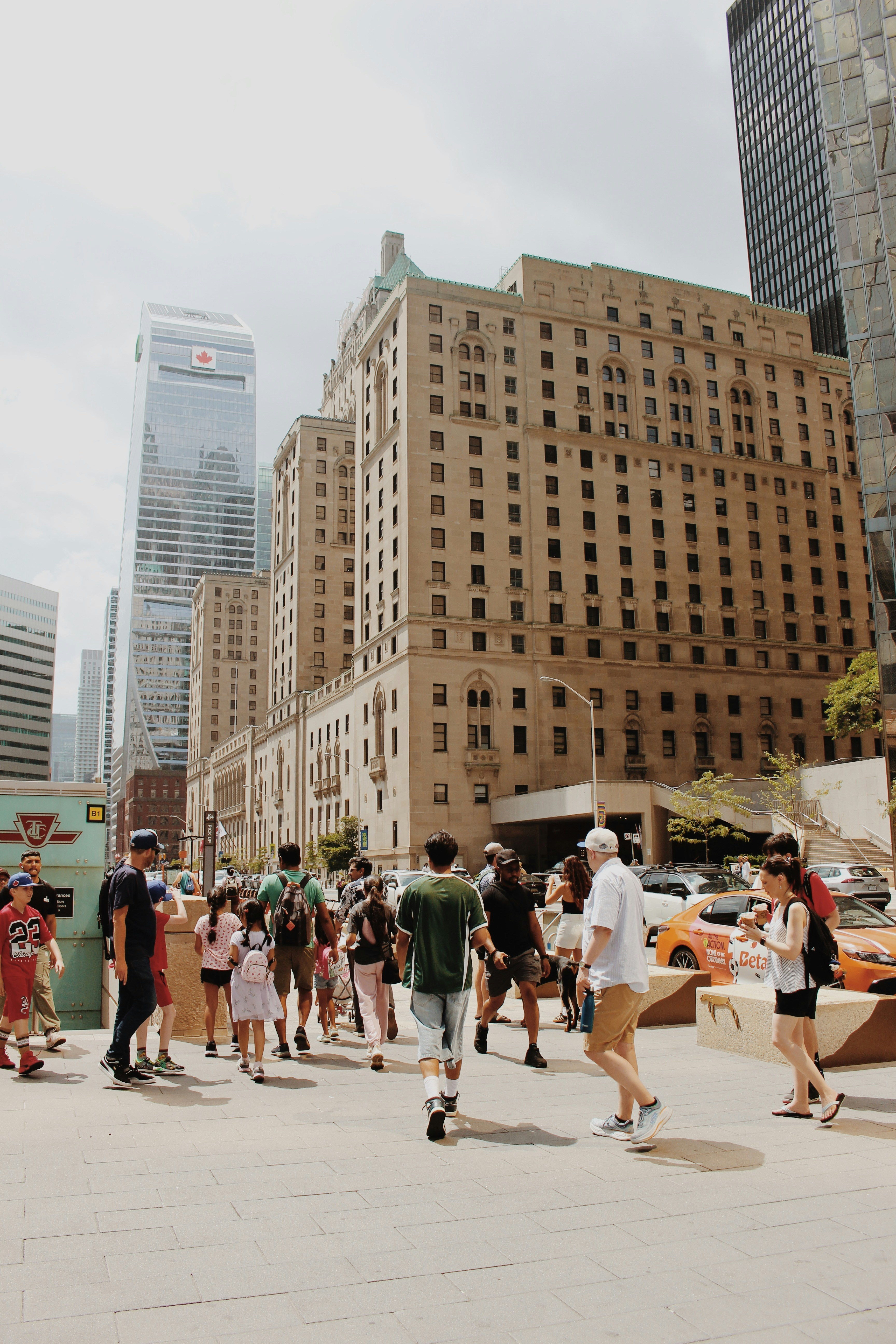 Crossroads of Midtown: People Crossing the Sunlit Avenue
