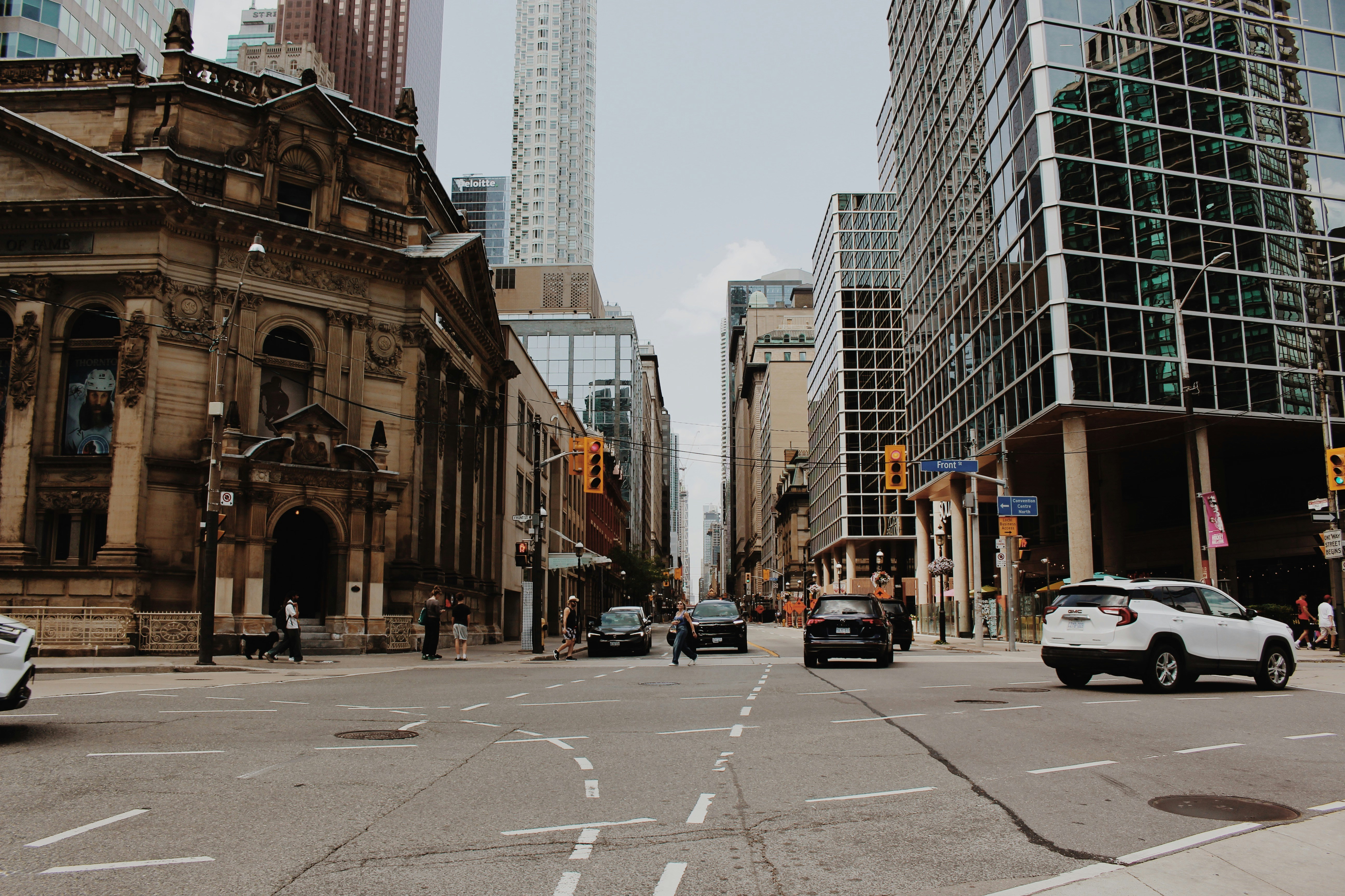 Urban Confluence: Cars and Skyscrapers Converge at a Busy Downtown Intersection