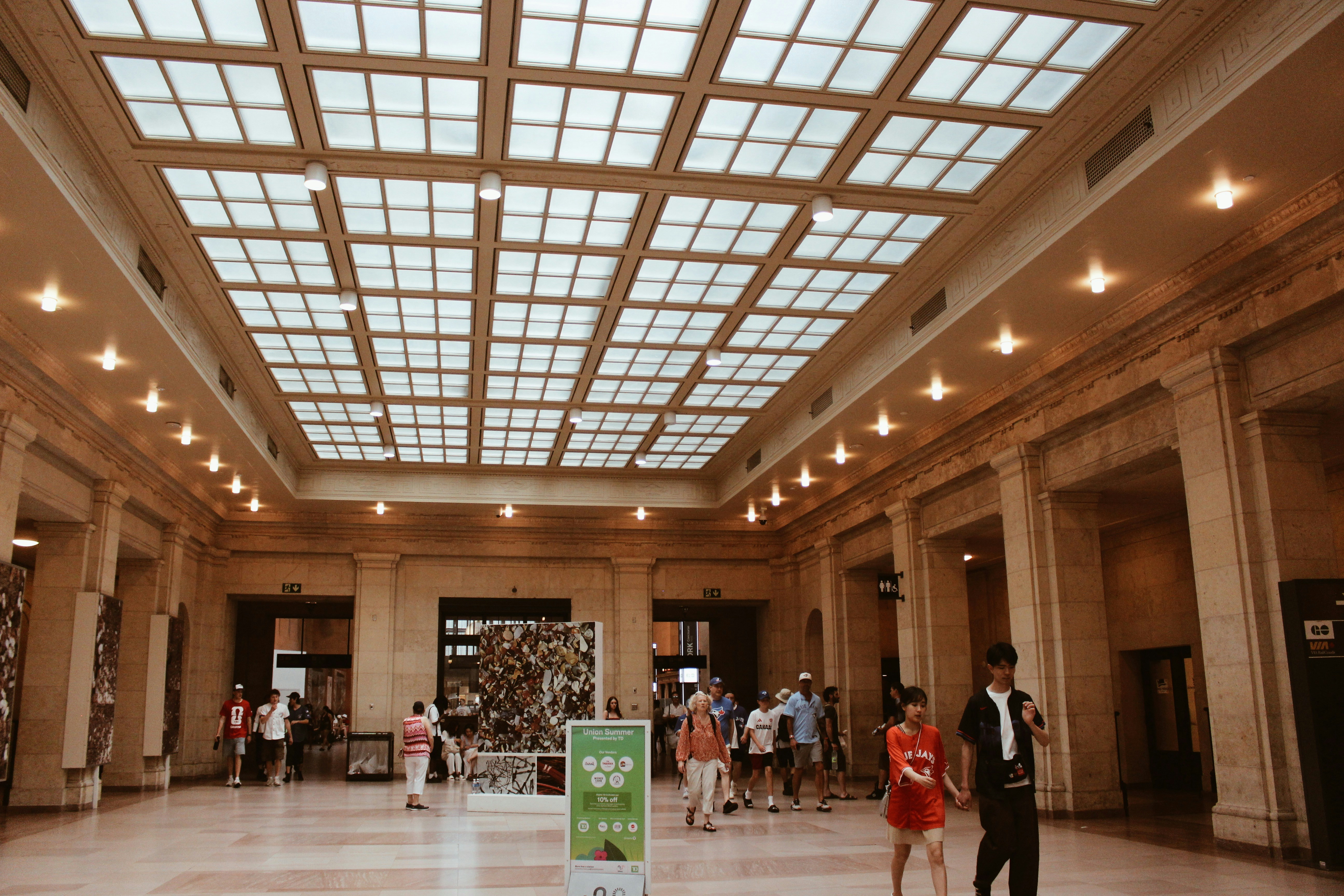 Grand Atrium Portrait: People Gather Beneath Skylit Cathedral
