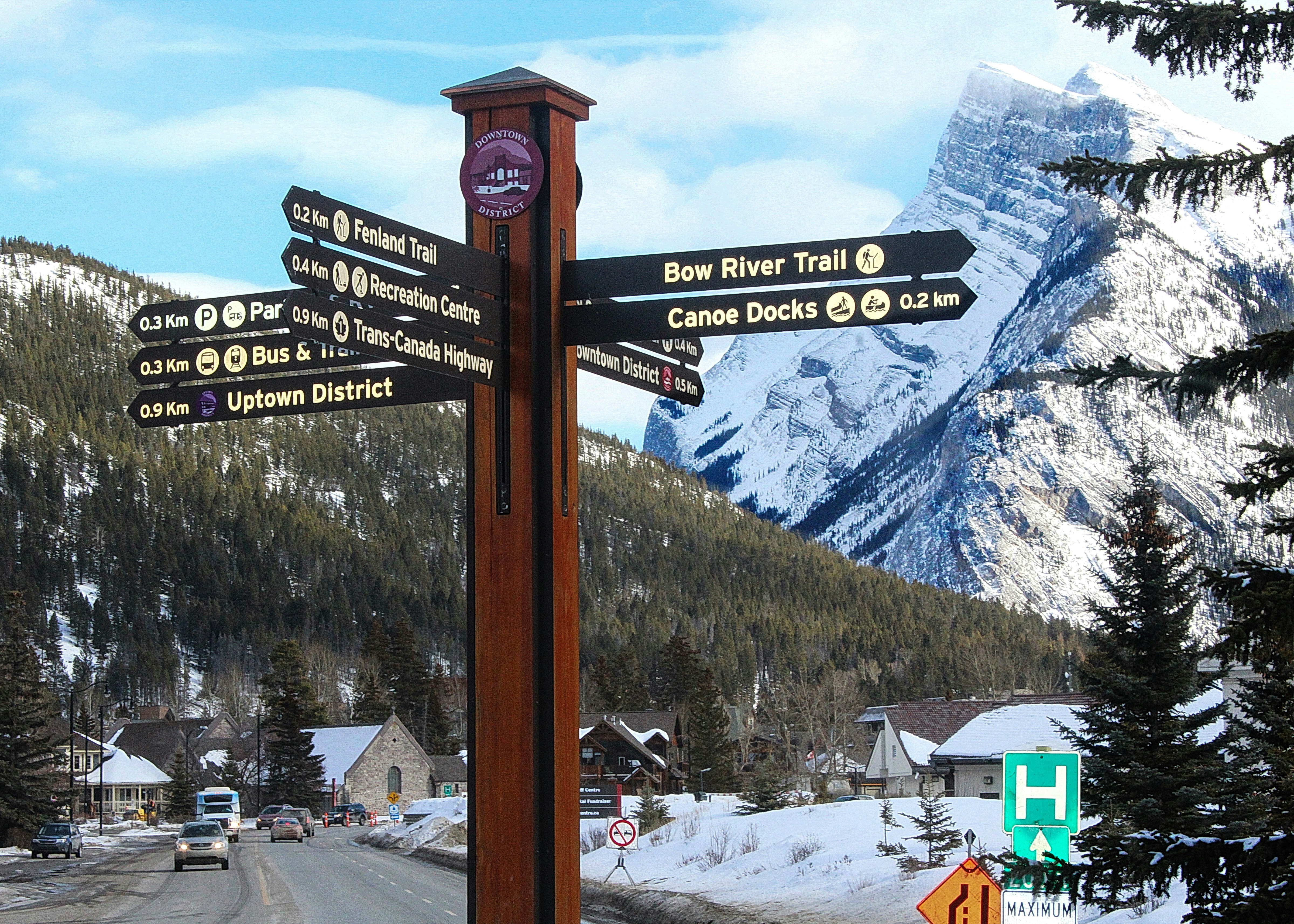 Snowy Town Signpost Beneath Alpine Peak