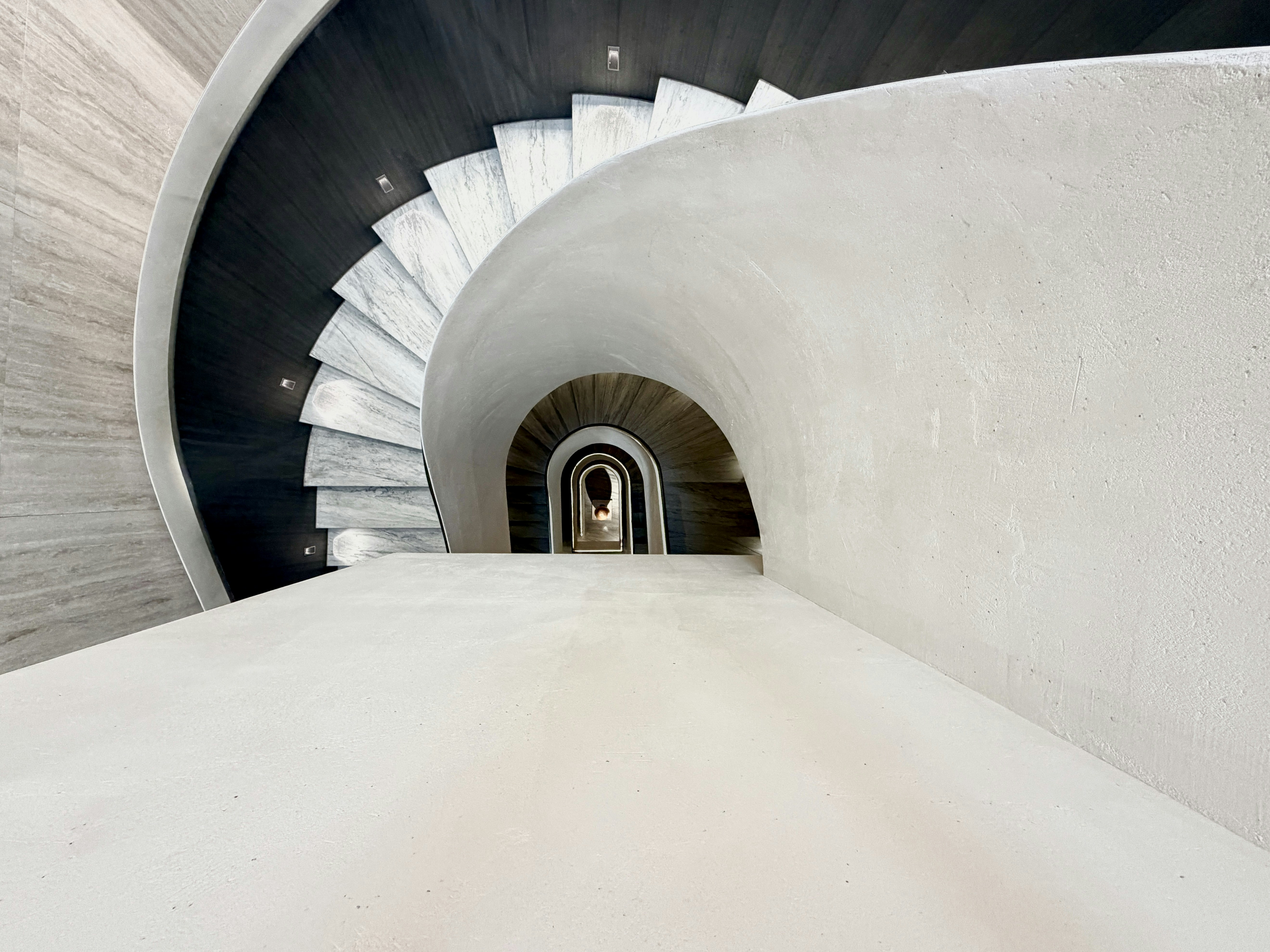 Spiral Ascent: A Cylindrical Staircase Framing Concentric Journeys
