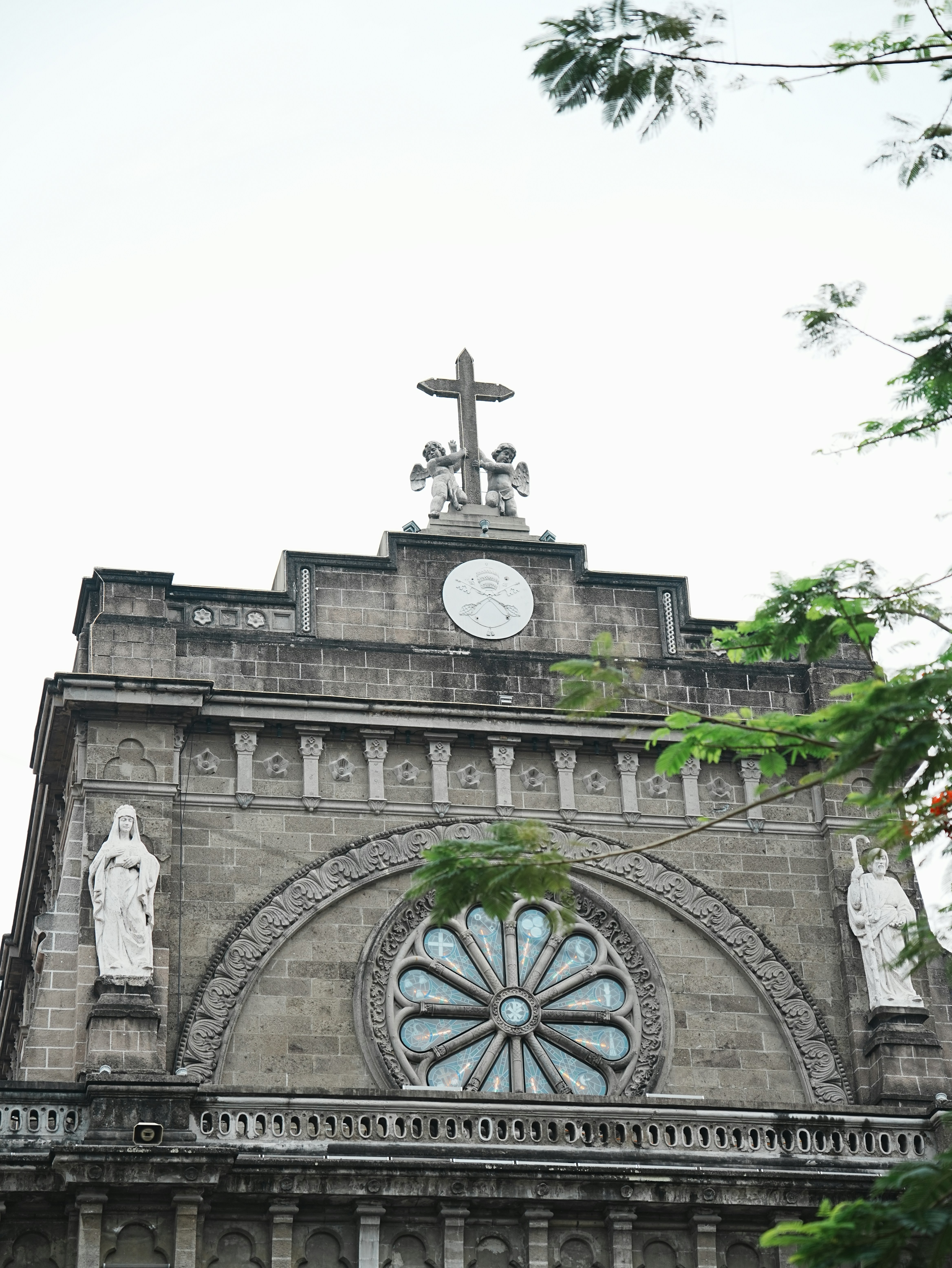 Cross and Circles: A Facade of Time Touched by Green