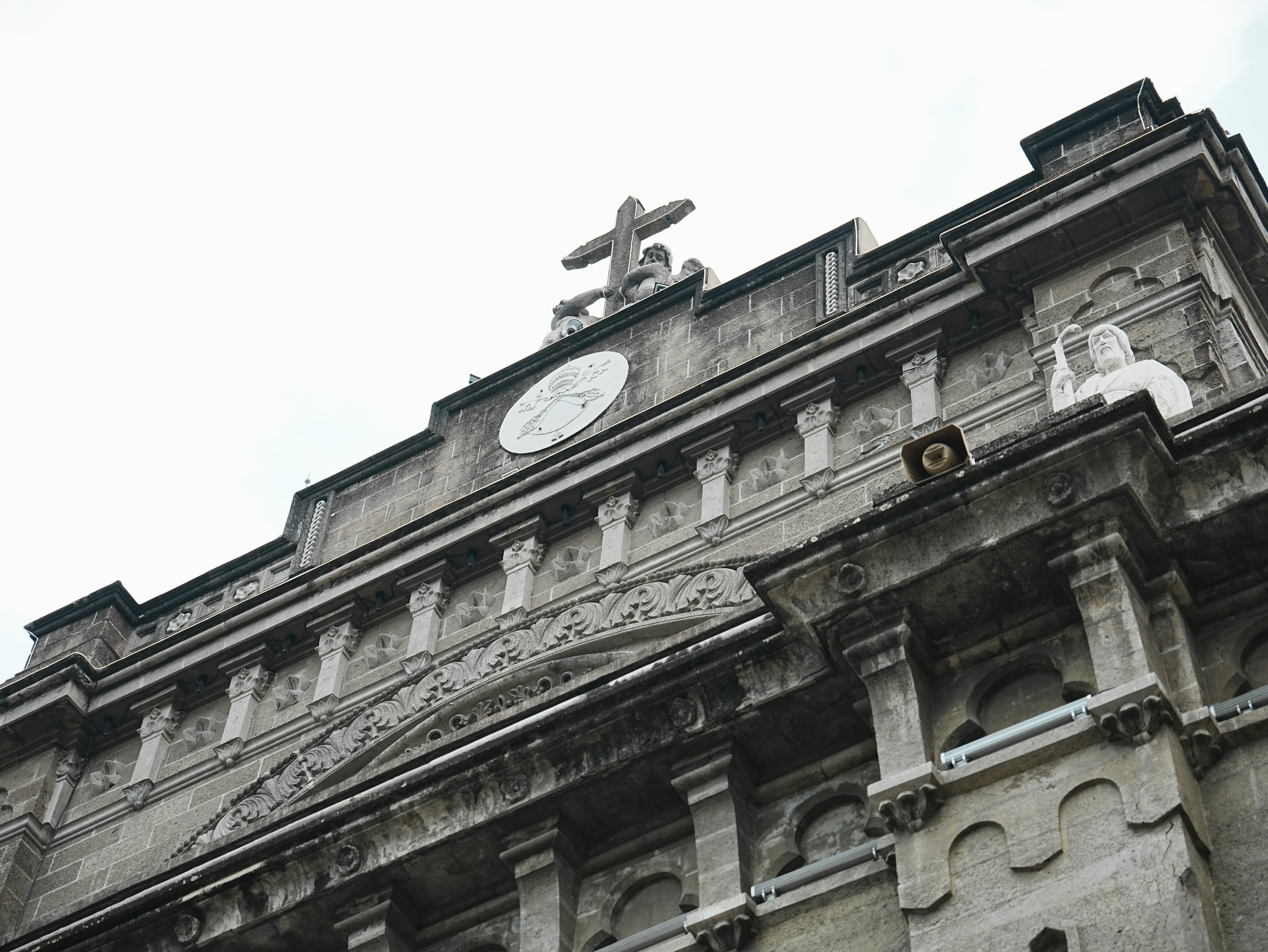 Old Facade, Concrete Carved Details Under An Oversized Cross