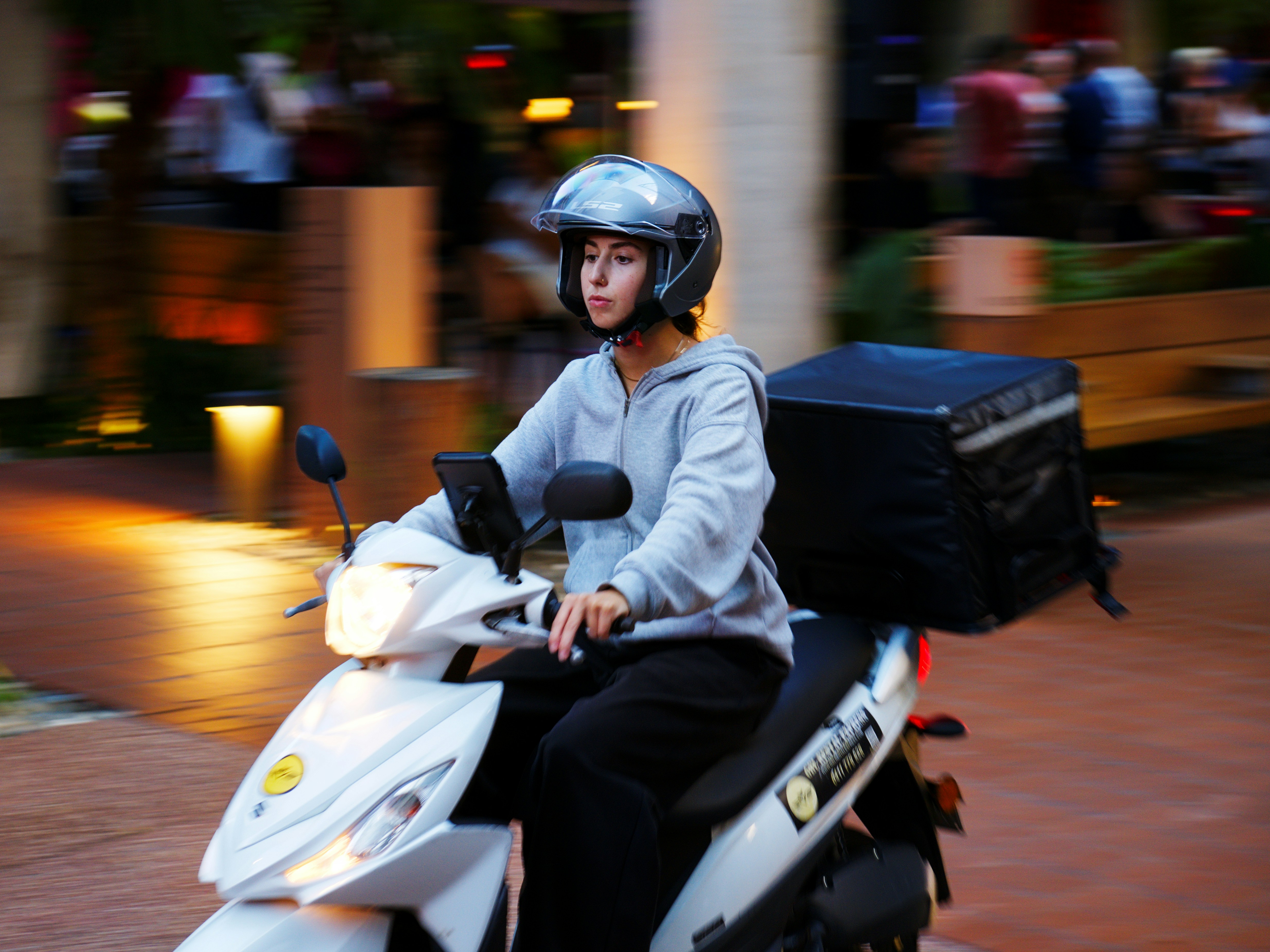 Quiet Focus: Rider with Helmet at Speed in an Urban Evening