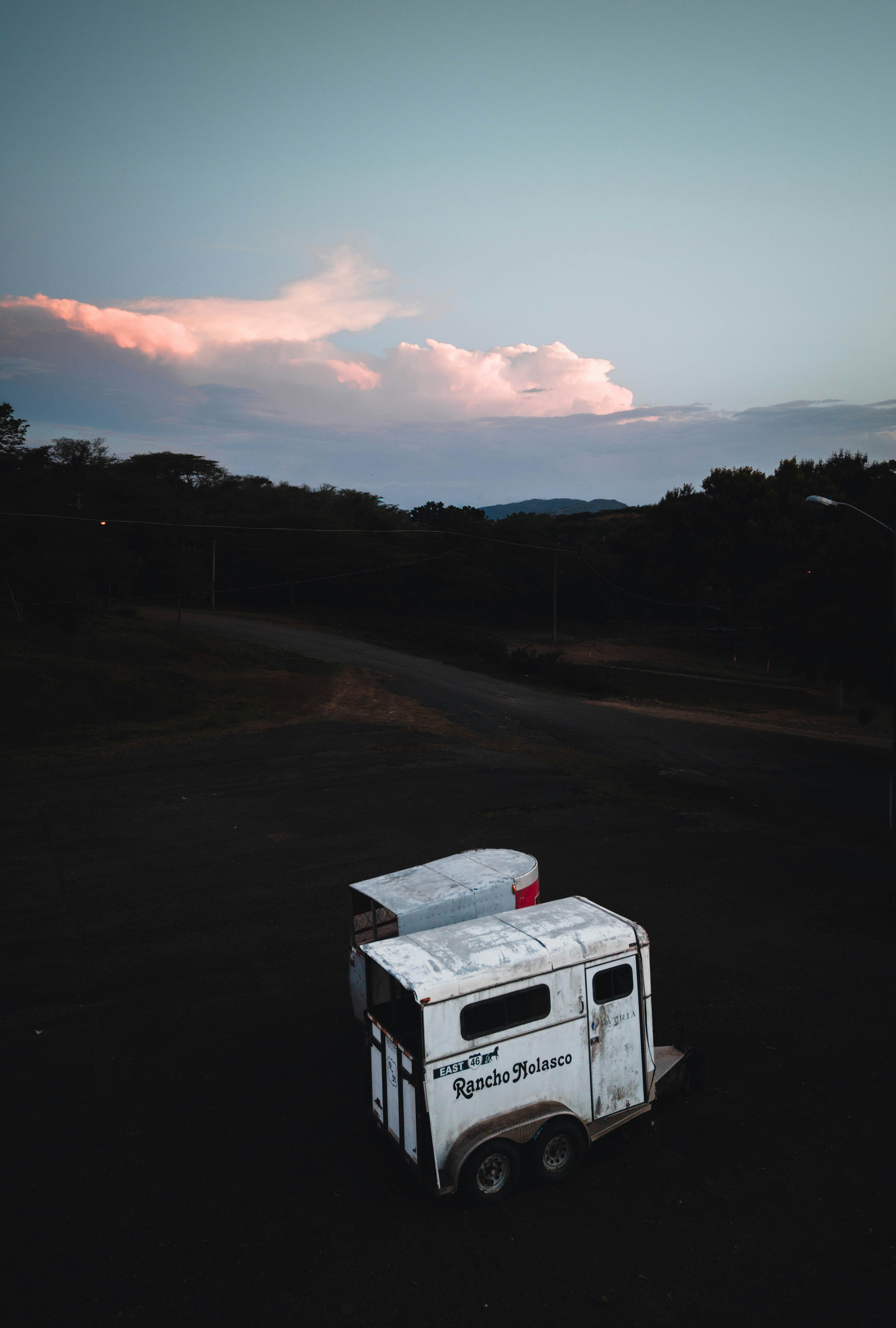 Deserted Wagon Under Dusk: A Lone Caravan Trailer in a Quiet Lot