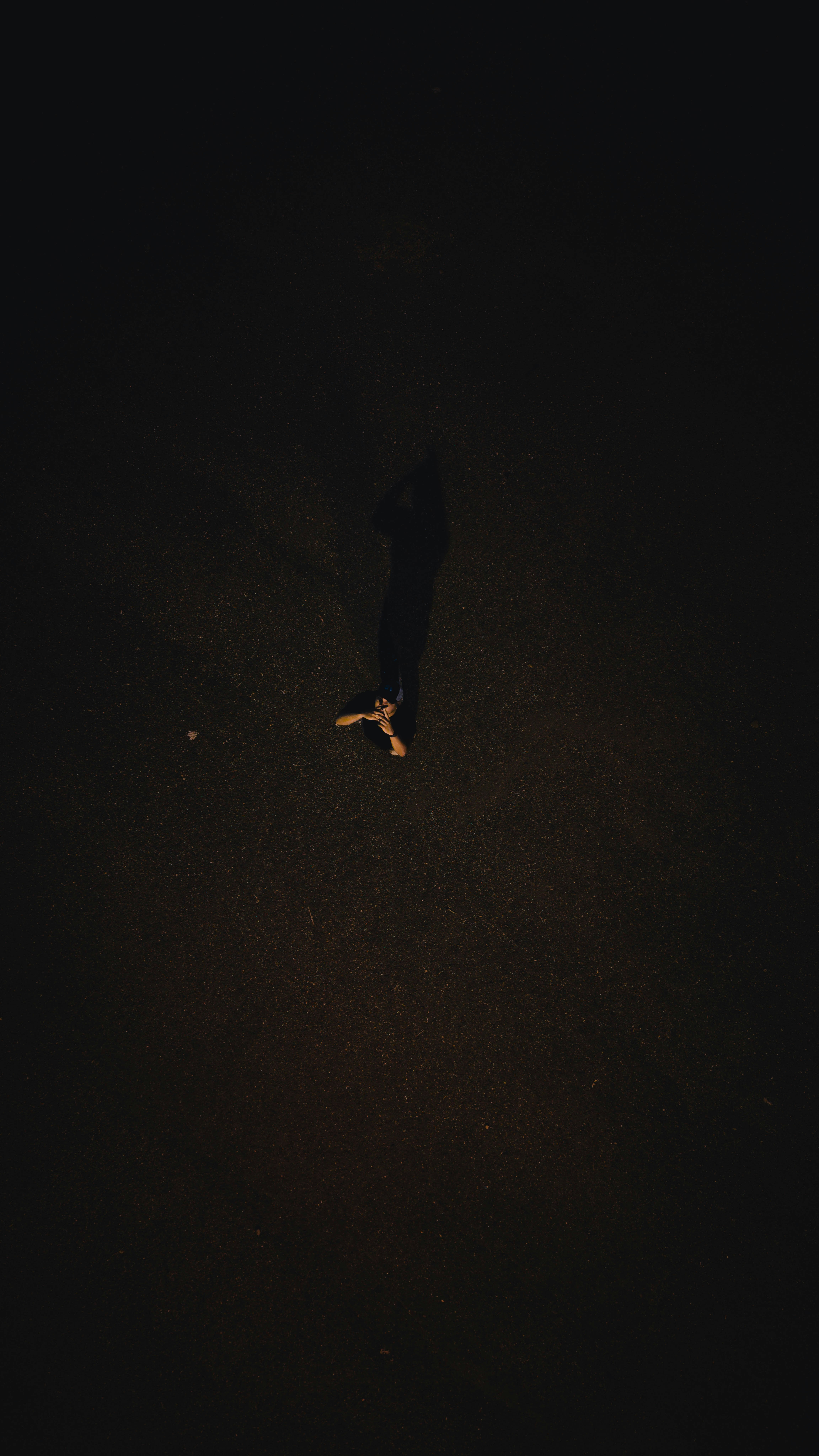 Midnight Figure: A Lone Silhouette on Quiet Asphalt