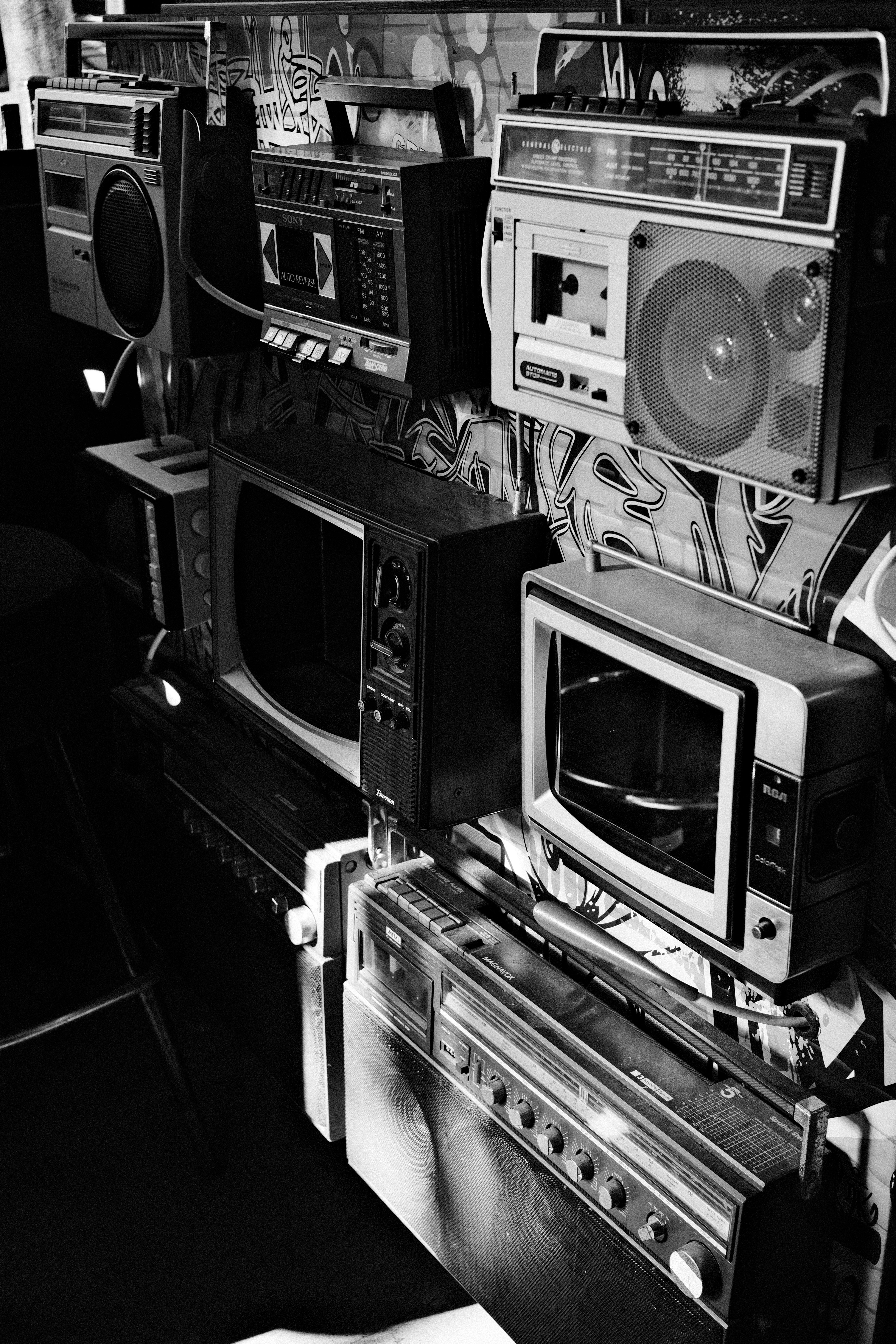 Vintage Echoes: A Wall of Retro Radios and TVs in Monochrome