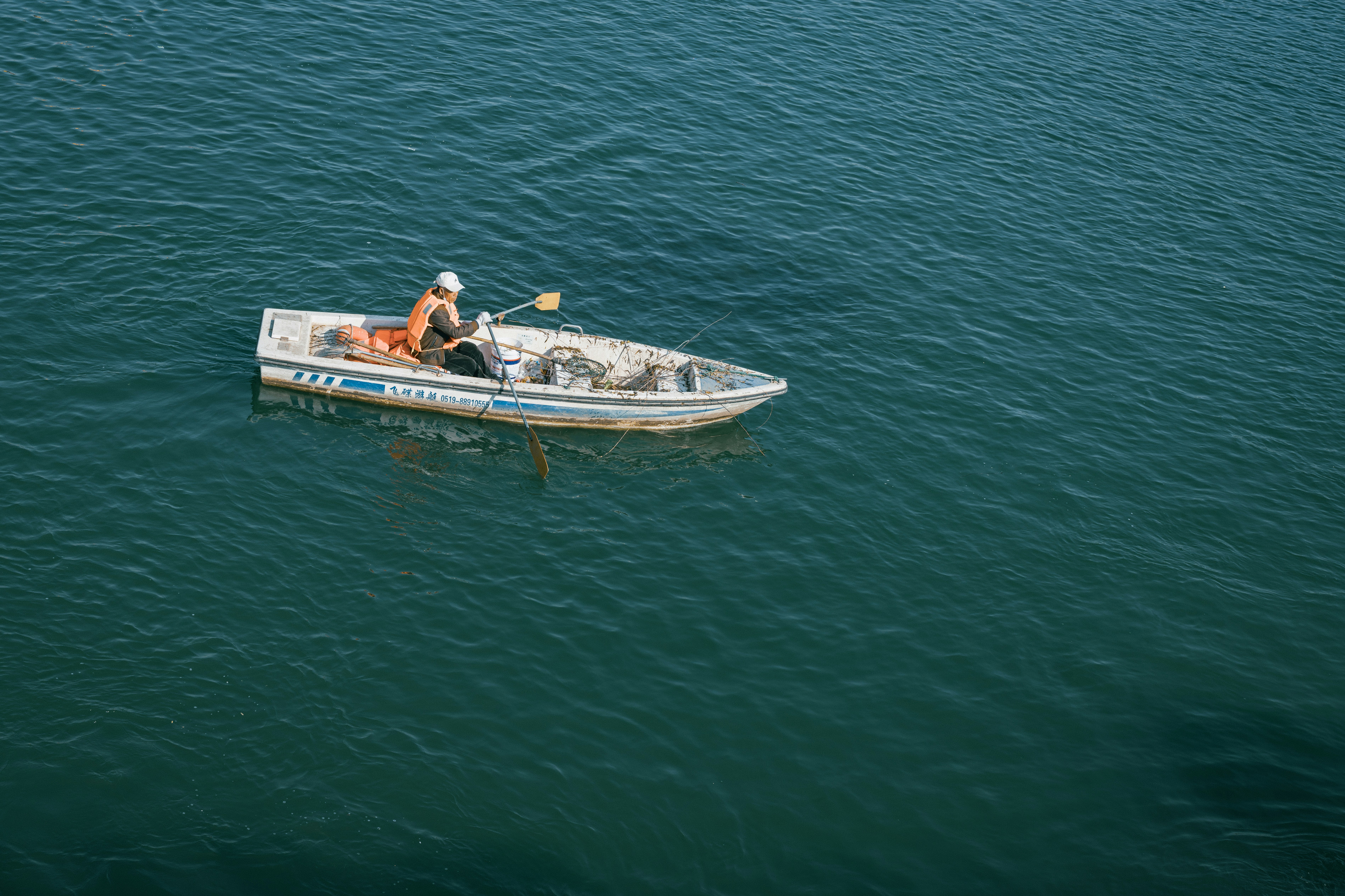 Lonely Rowboat Adrift on Quiet Blue Waters