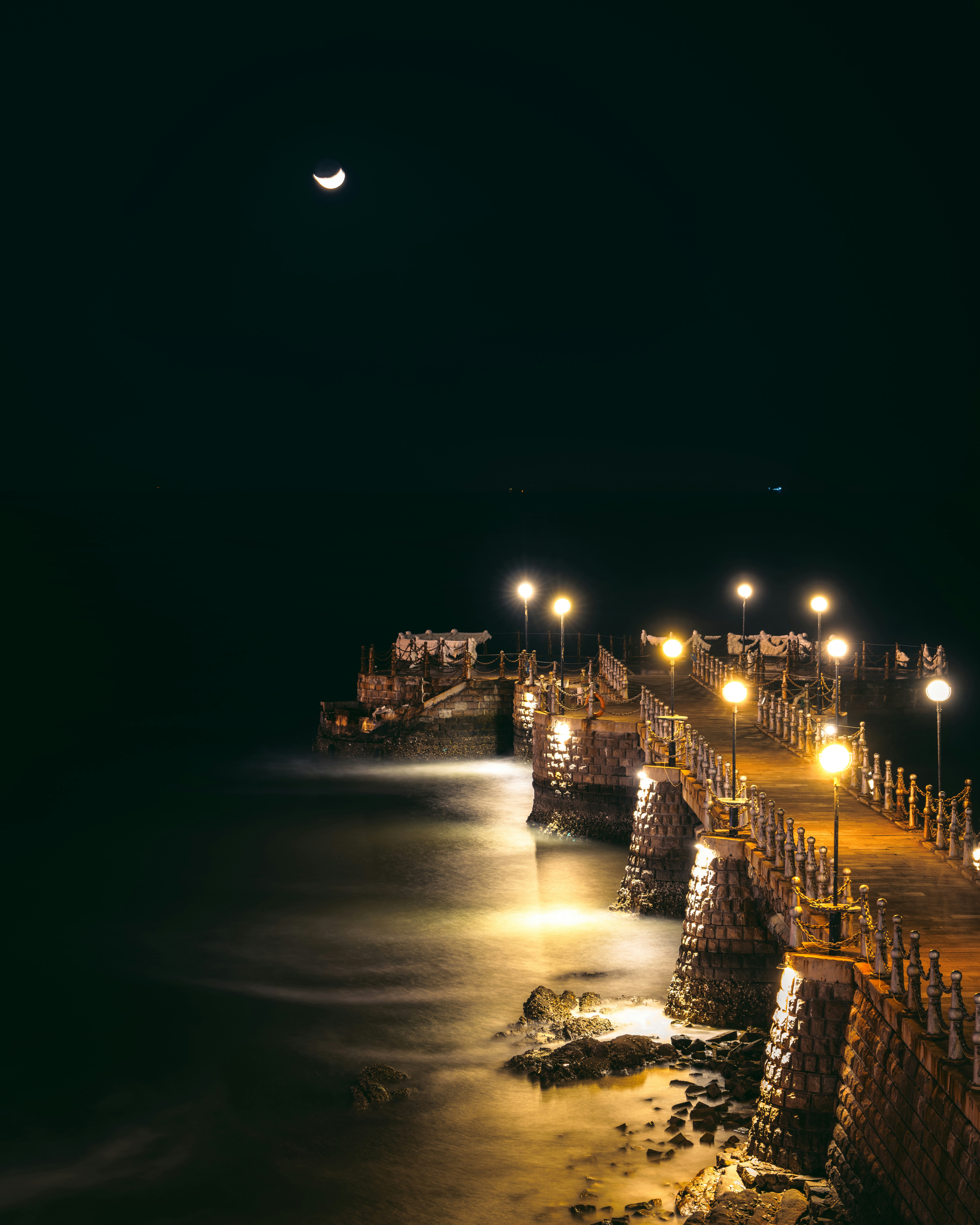 Moonlit Pier: Lanterned Walkway Into the Night