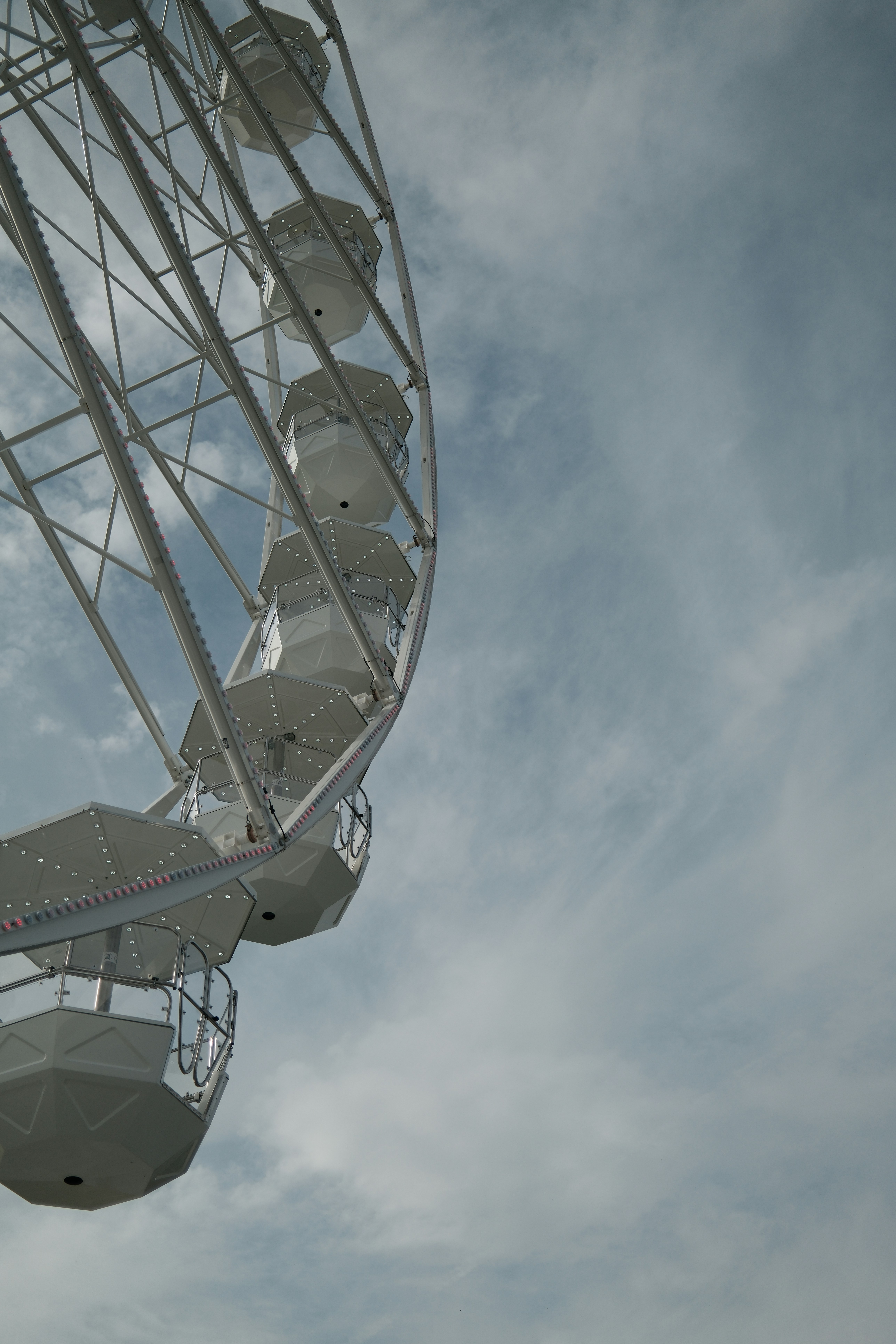 Ferris Wheel Gondolas Stretching Against a Wide Sky
