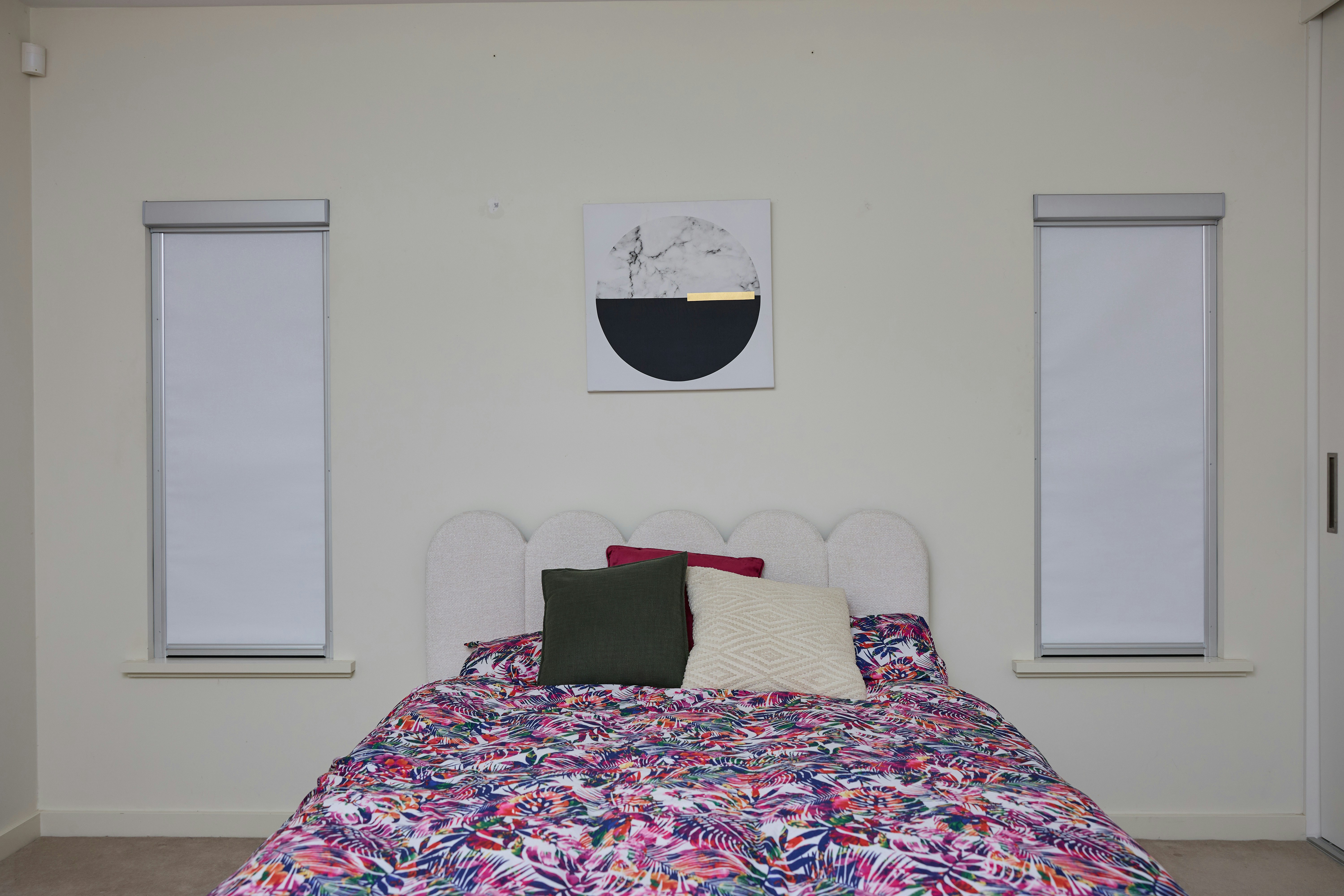 Symmetrical bedroom retreat with a colorful floral duvet