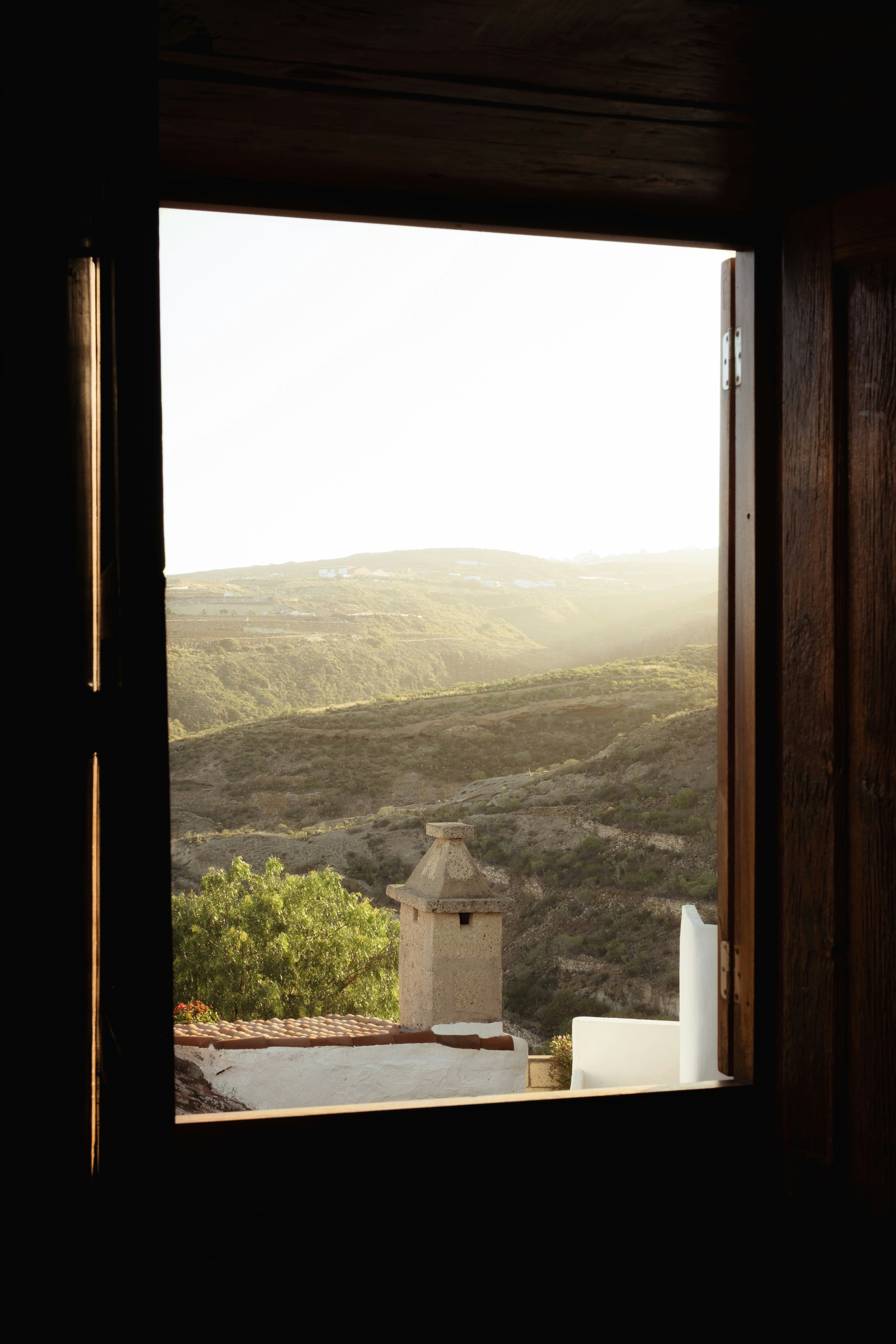 Window to a sunlit hillside village