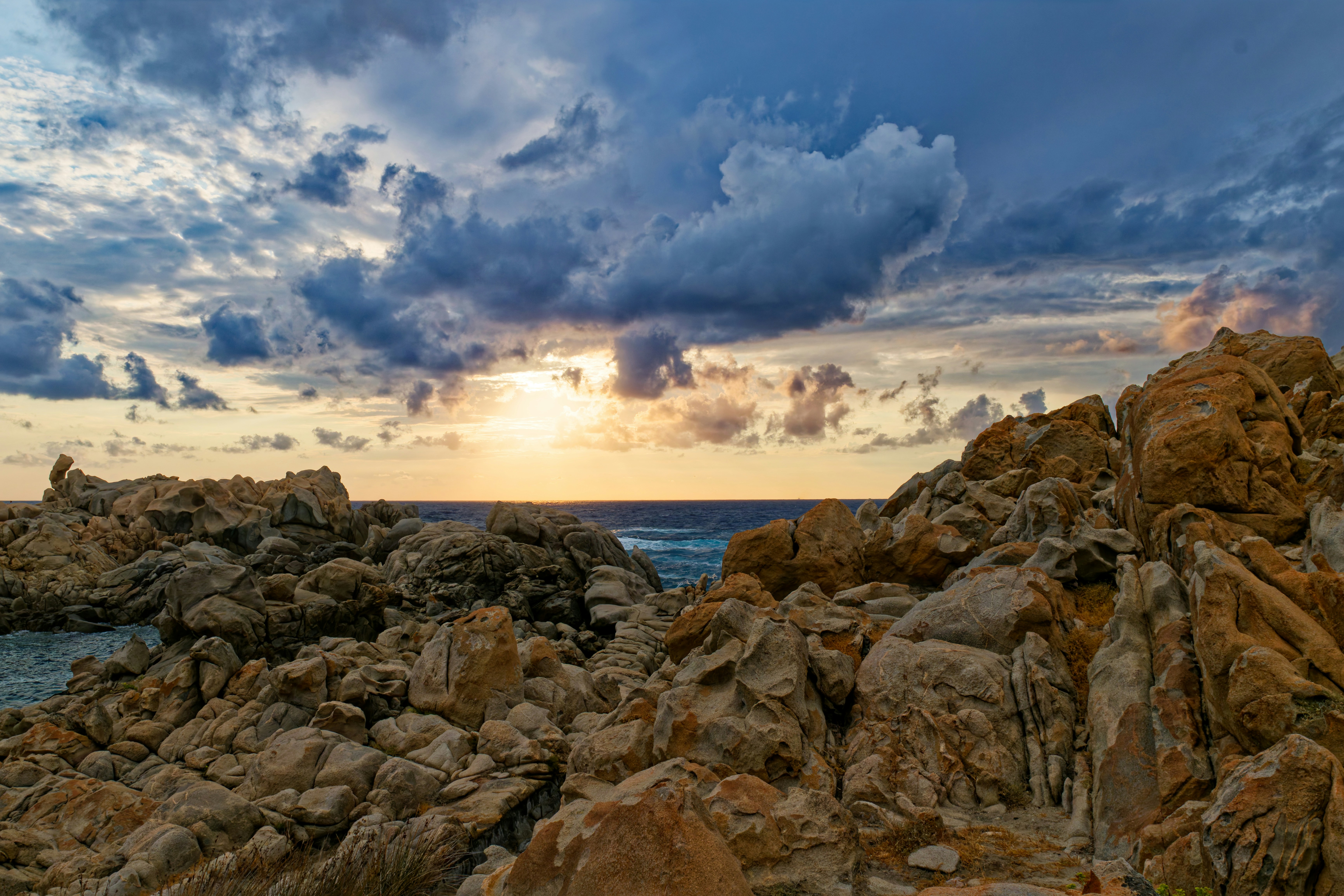 Sunlit Tides Under Rugged Cliffs