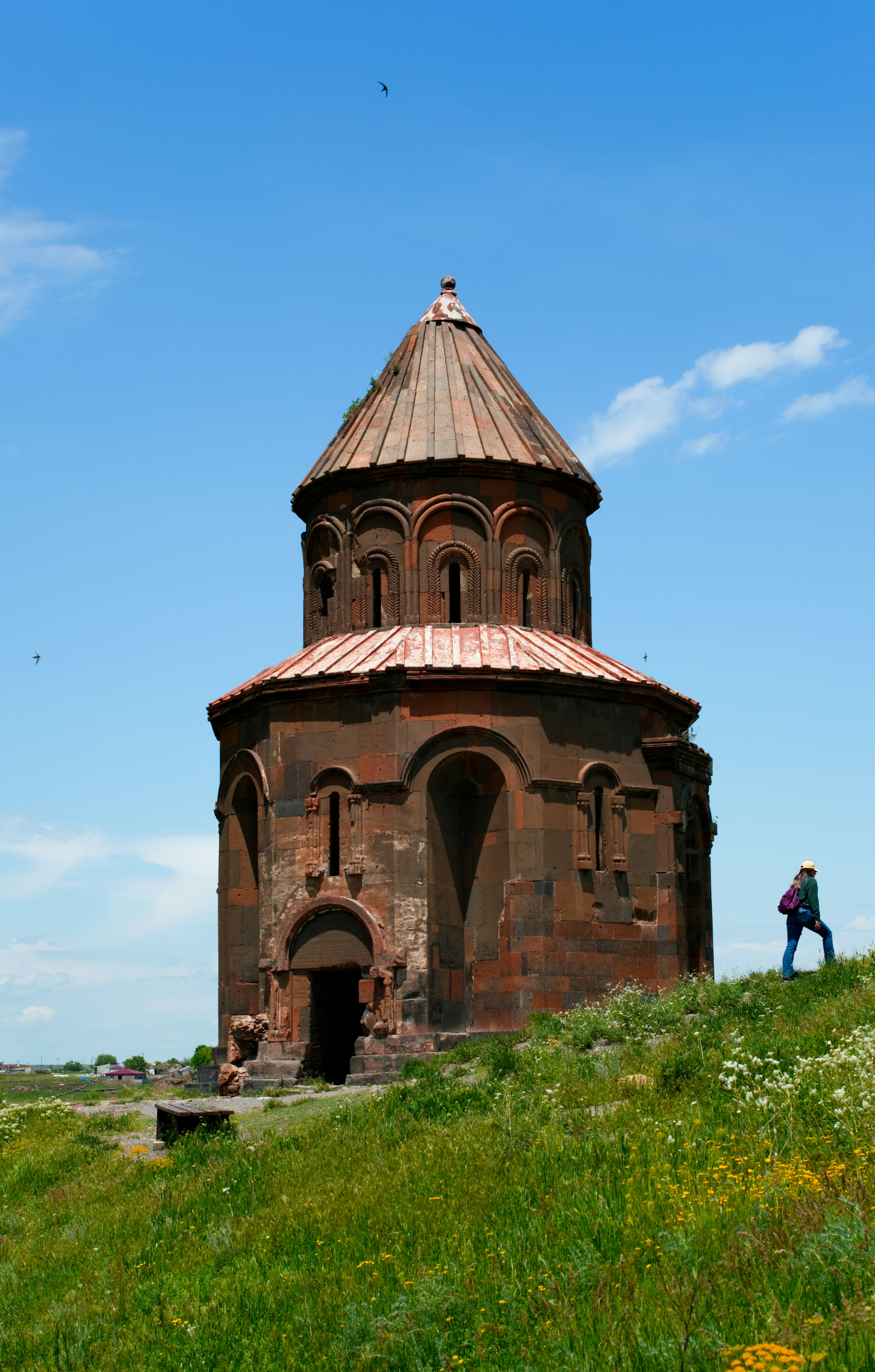 Stone Rotunda Rising: A Hilltop Shrine Under a Bright Arc