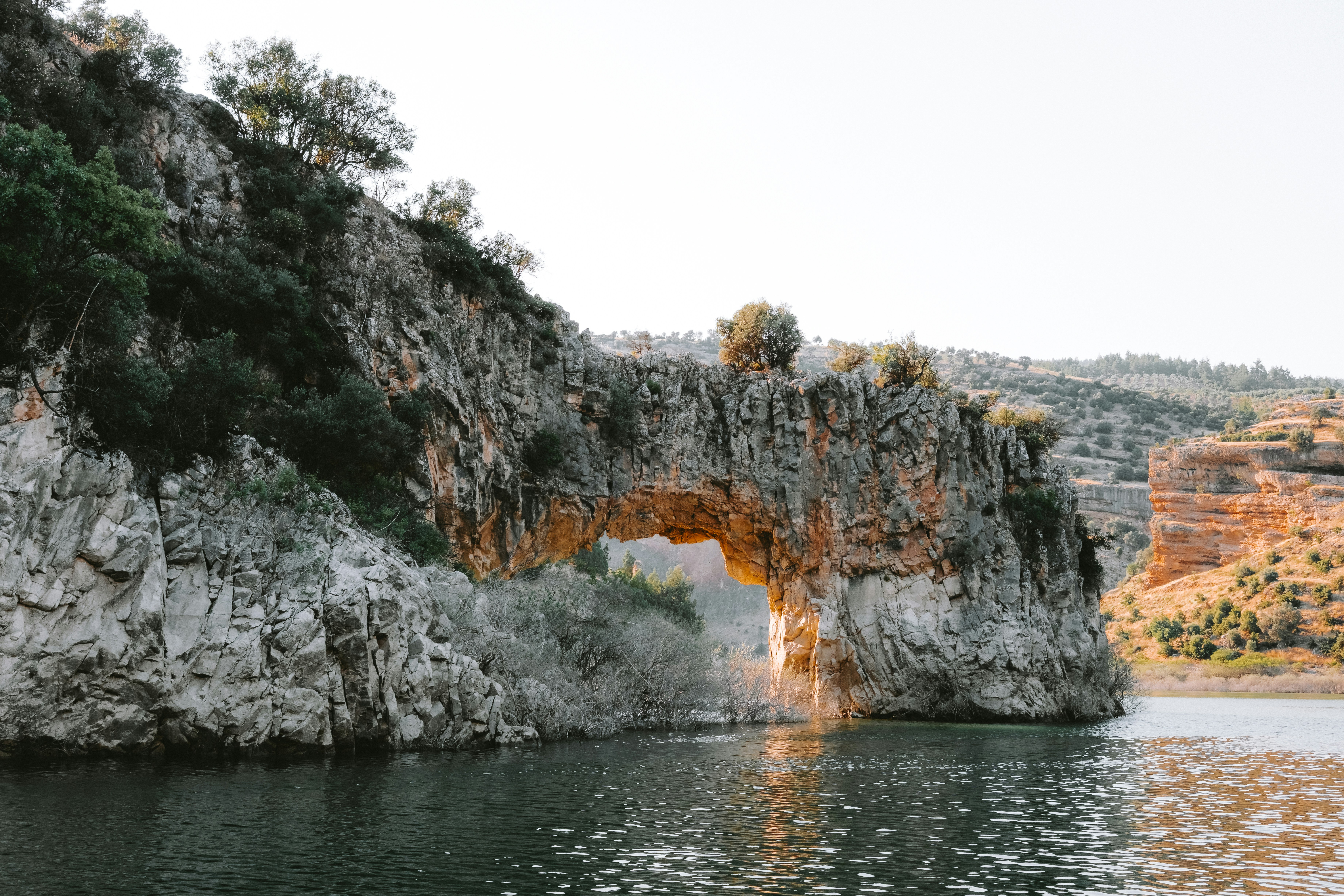 Natural Stone Arch Over A Quiet River