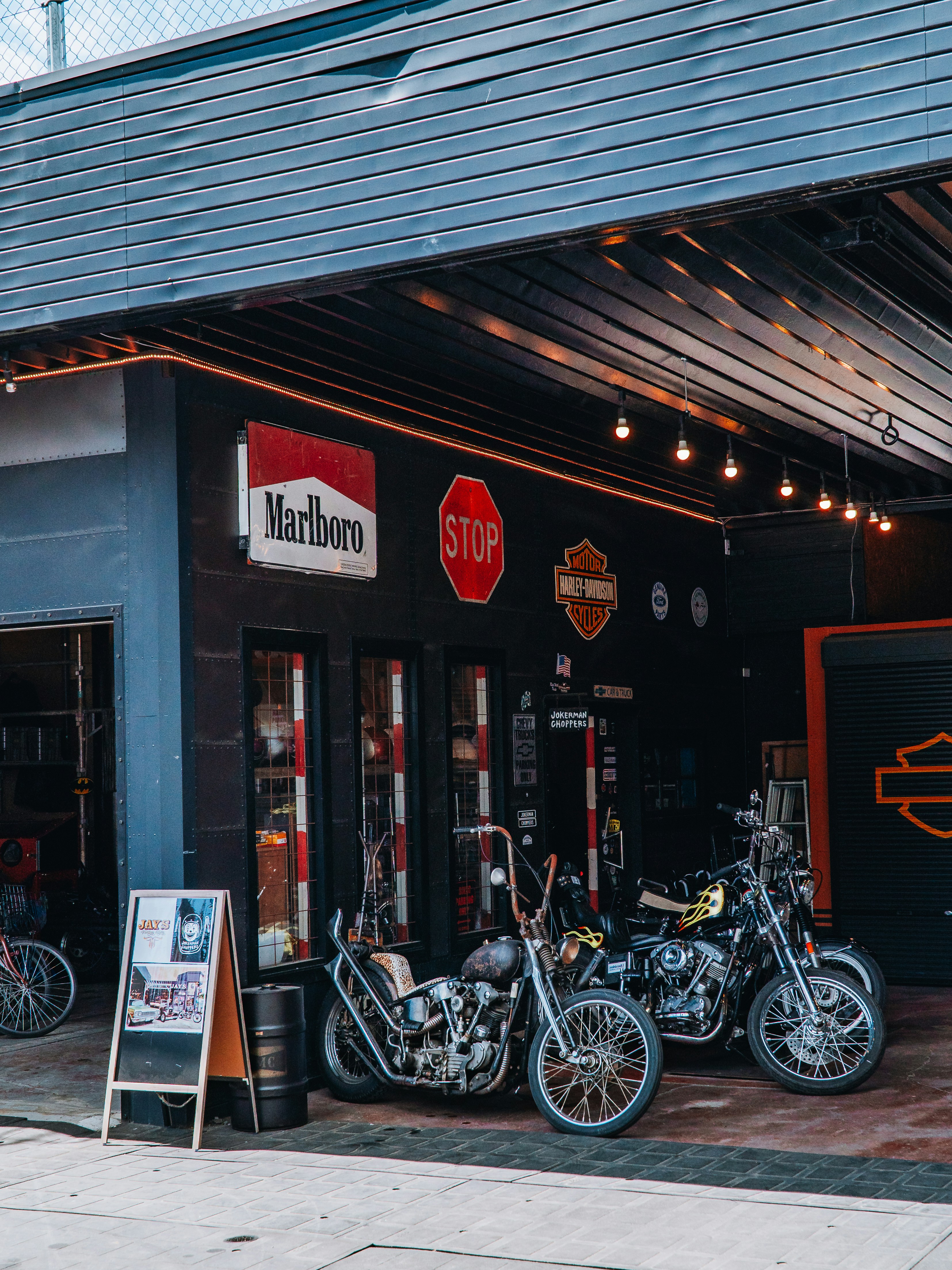 Motorcycle Shopfront Under Neon Glow