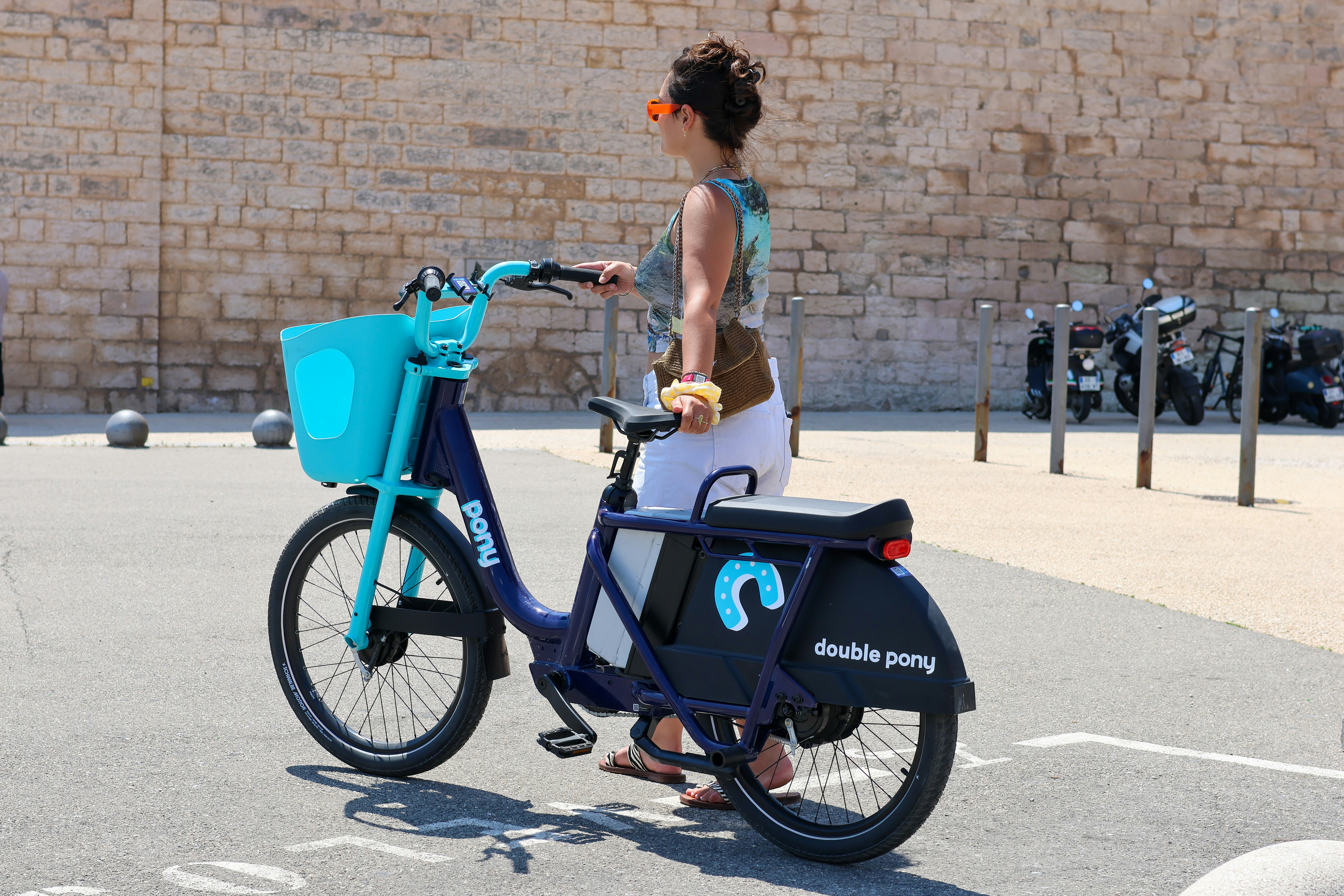 Pedal-Powered City Muse: A Cruising E-Bike by the Brick Wall