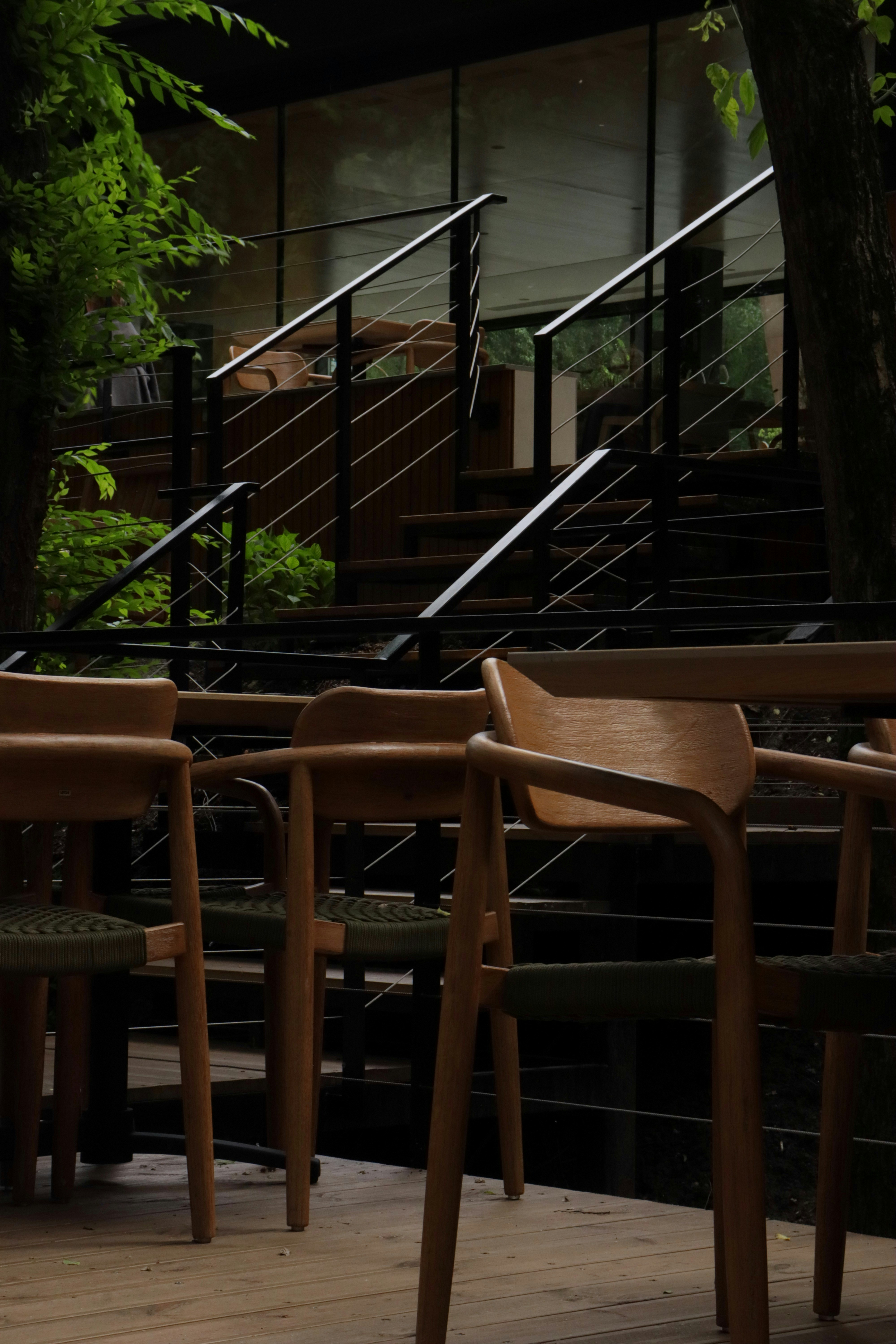 Muted Bistro Terrace Amidst Steel Railing and Wooden Seating
