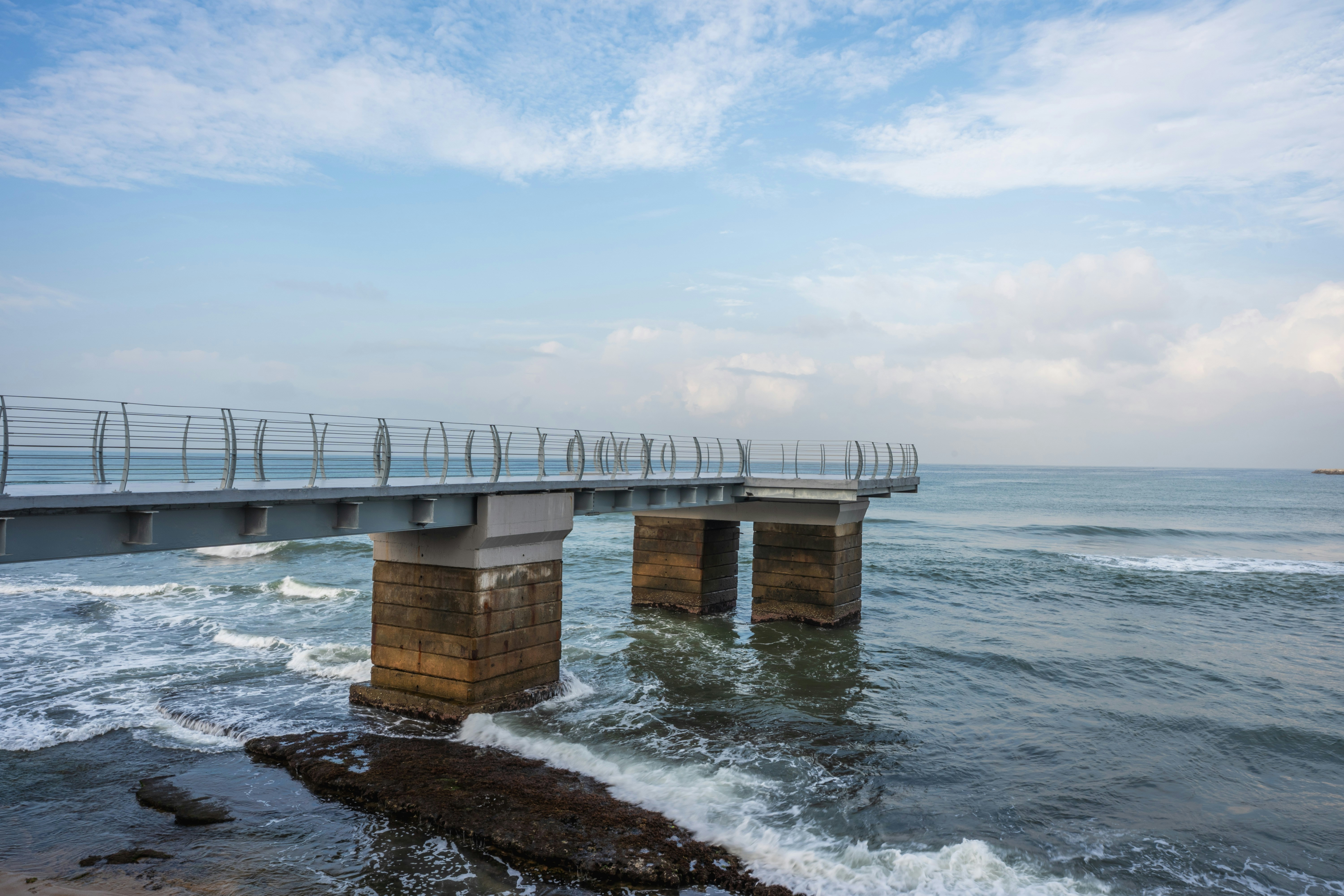 Bridge over Quiet Seas: A Coastal Pier Reaches into the Horizon