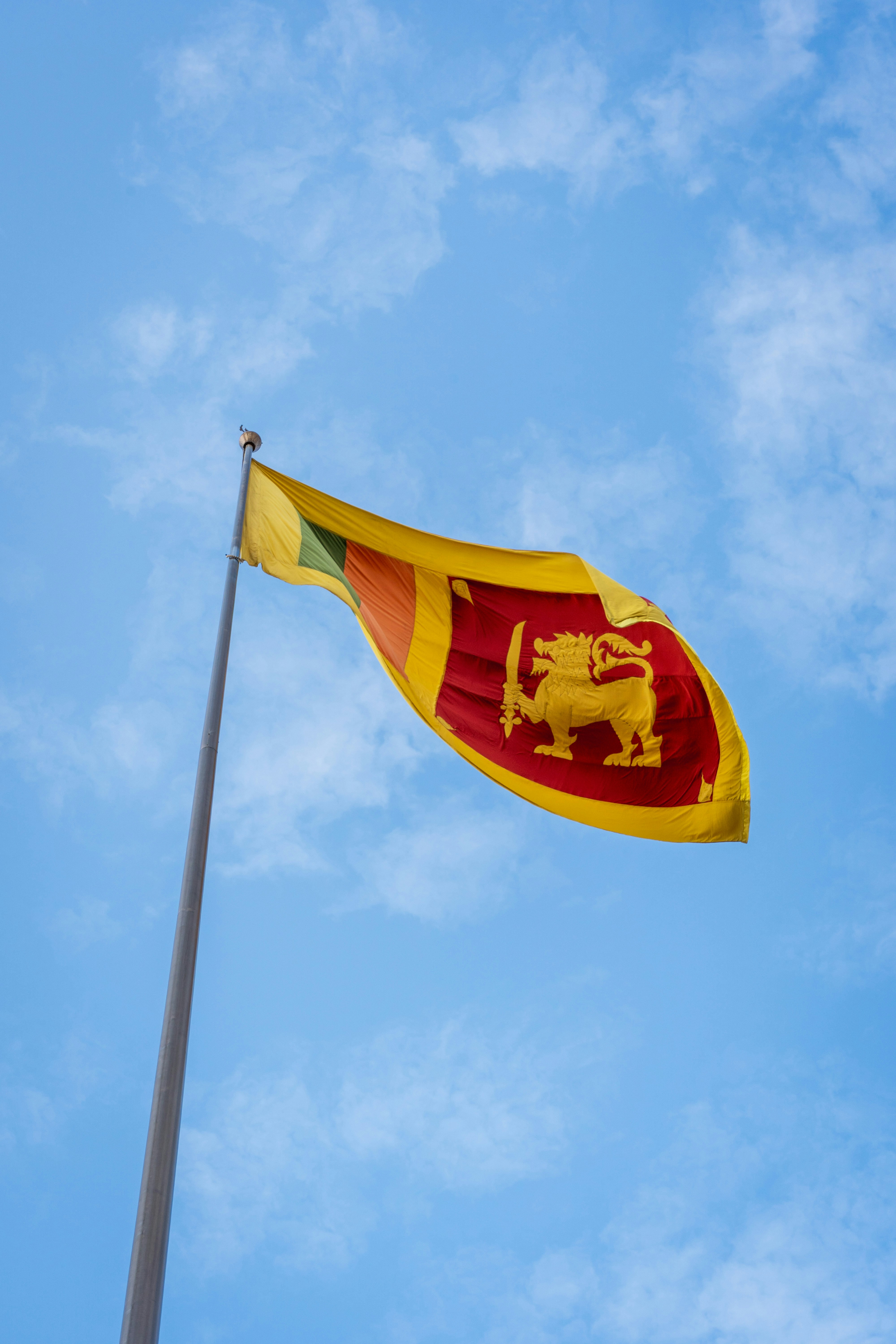 Flag of Sri Lanka catching a breeze against a clear blue sky