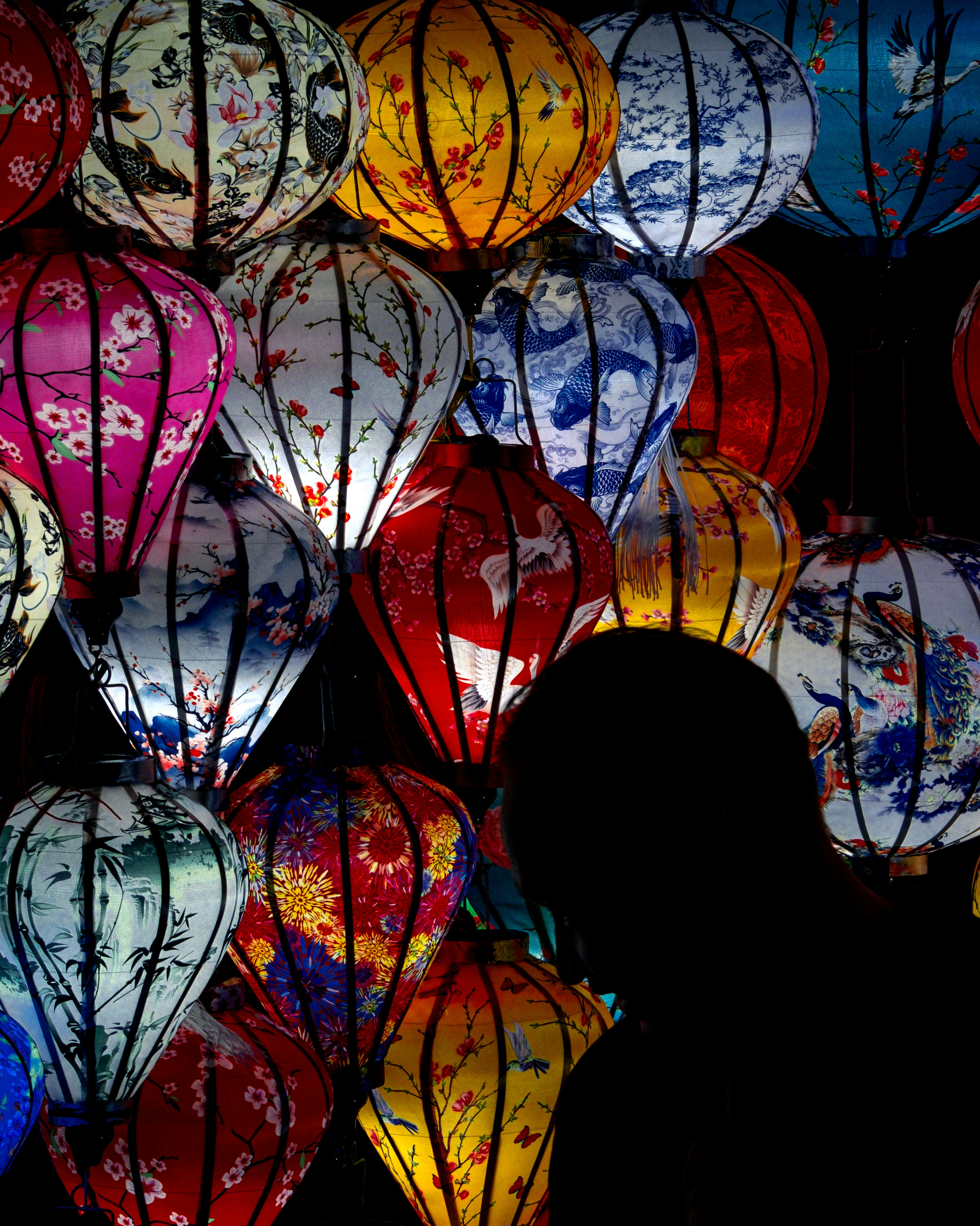 Silhouette Among Lanterns: A Night Market Glow