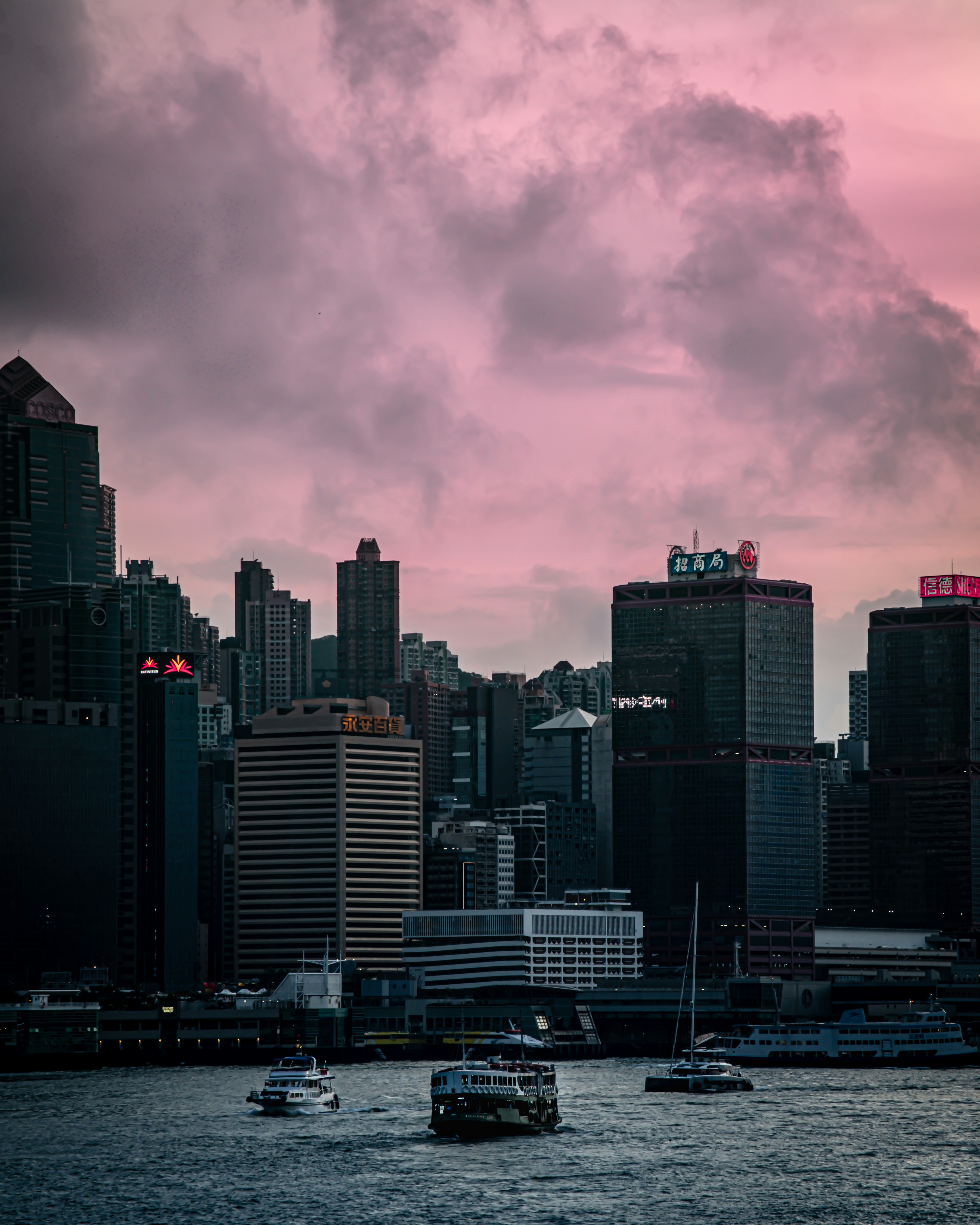 City Skyline at Dusk: Boats, Bridges, and Pink Haze