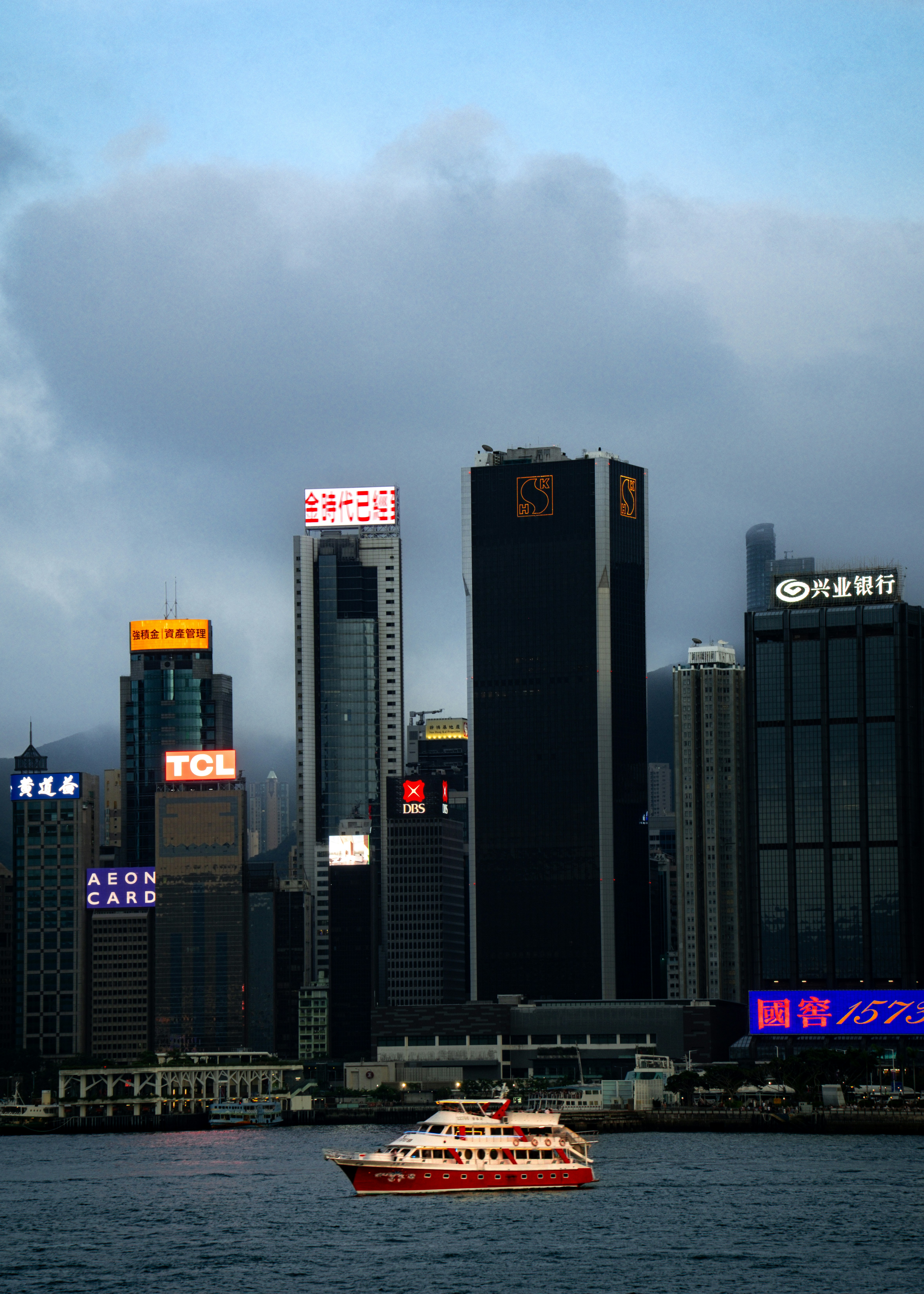 City of Glass: A Red Boat Amid Neon Skyscrapers