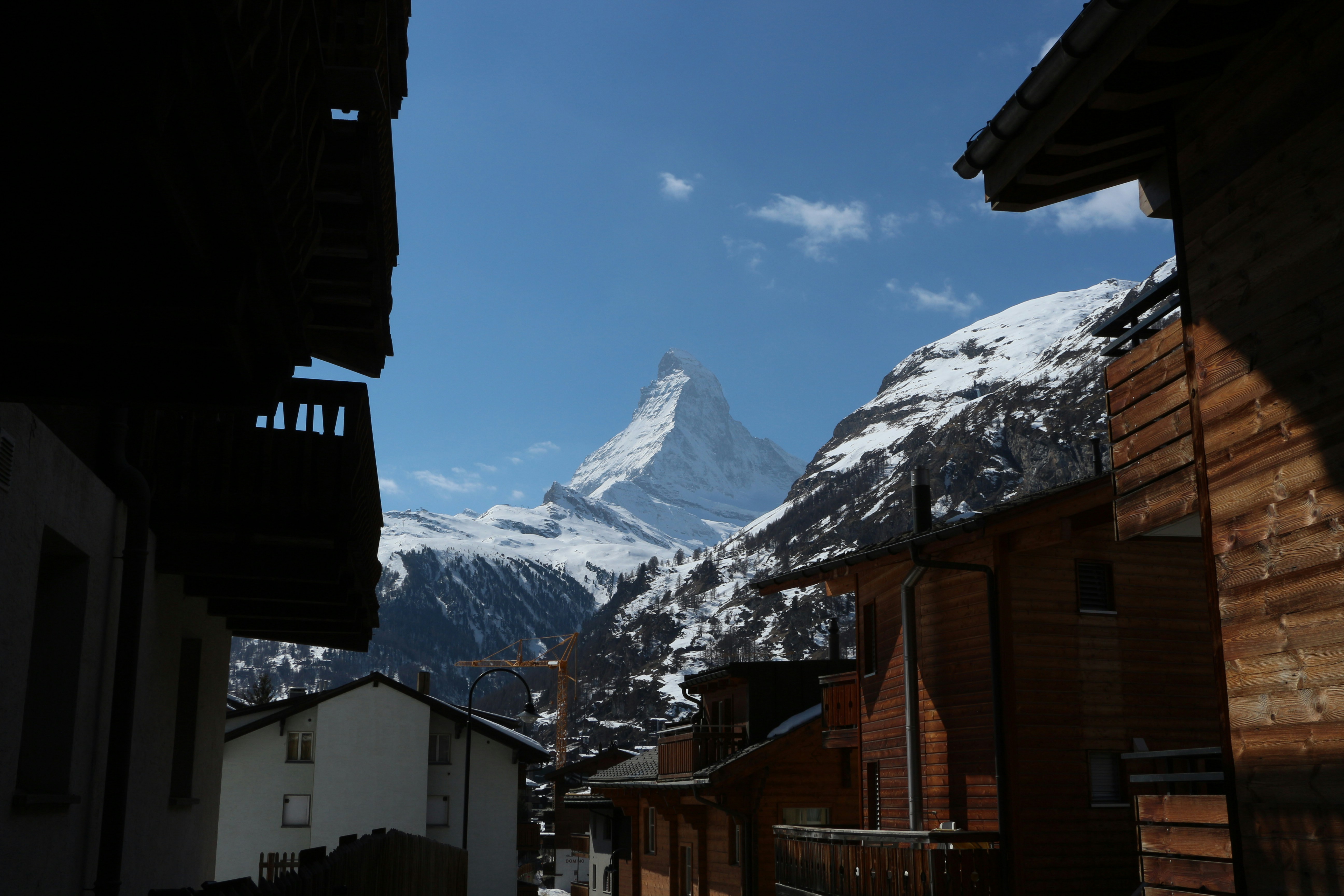 Snow-Capped Peak Framed Between Timbered Alleys