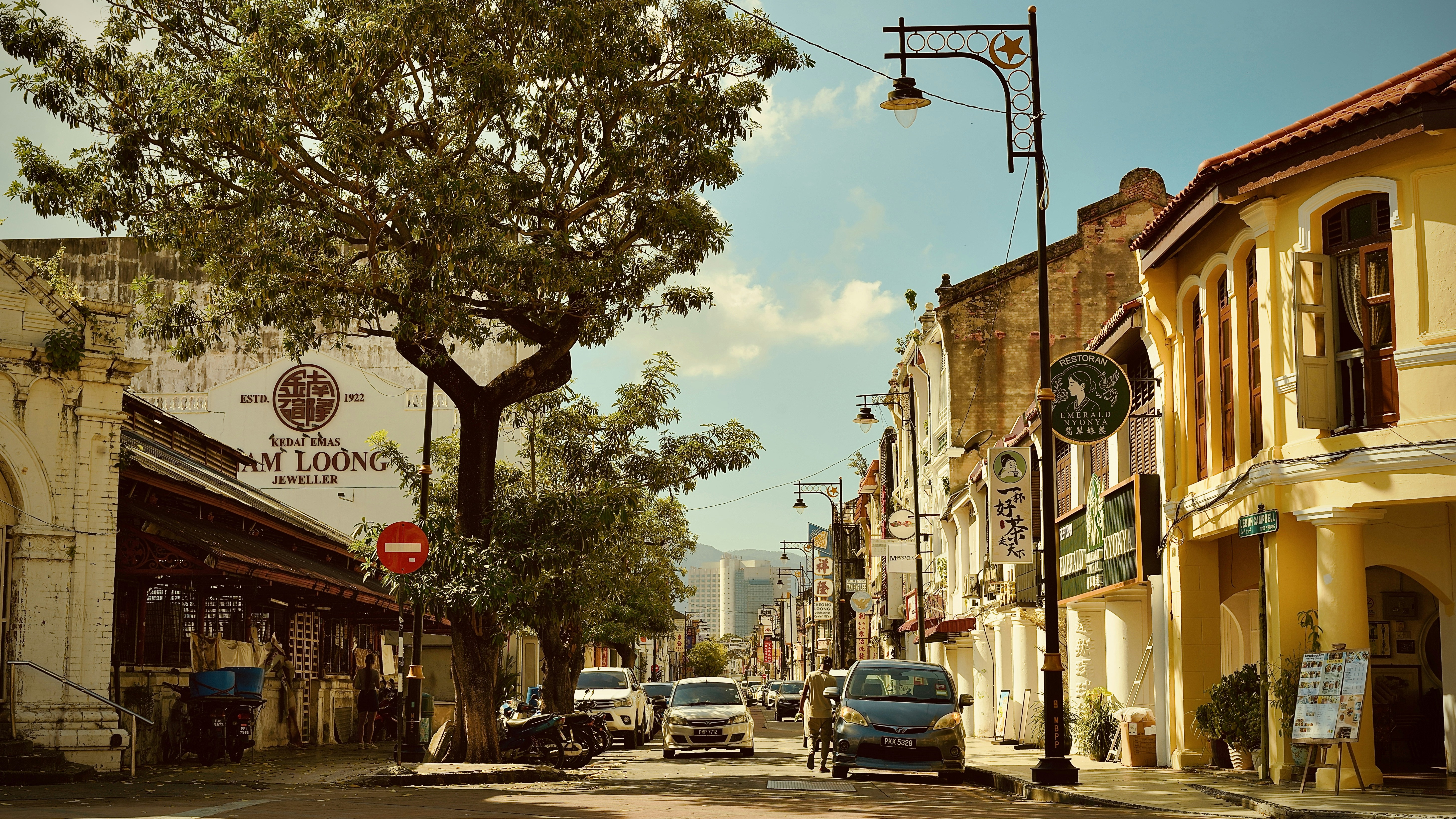 Sunlit Main Street: Vintage Architecture and Curbside Life