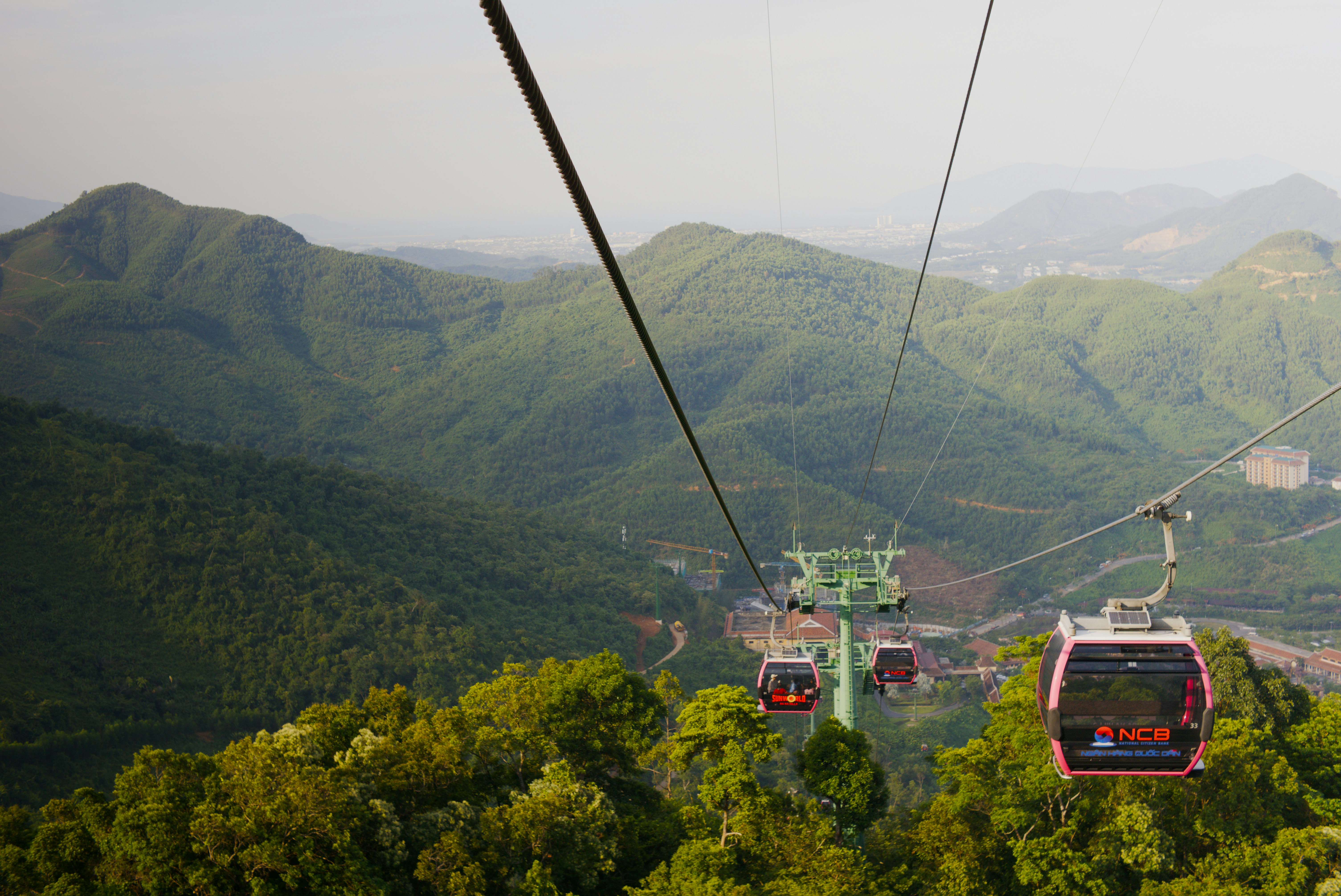 Ascending Above the Emerald Valleys on a Mountain Cable Car