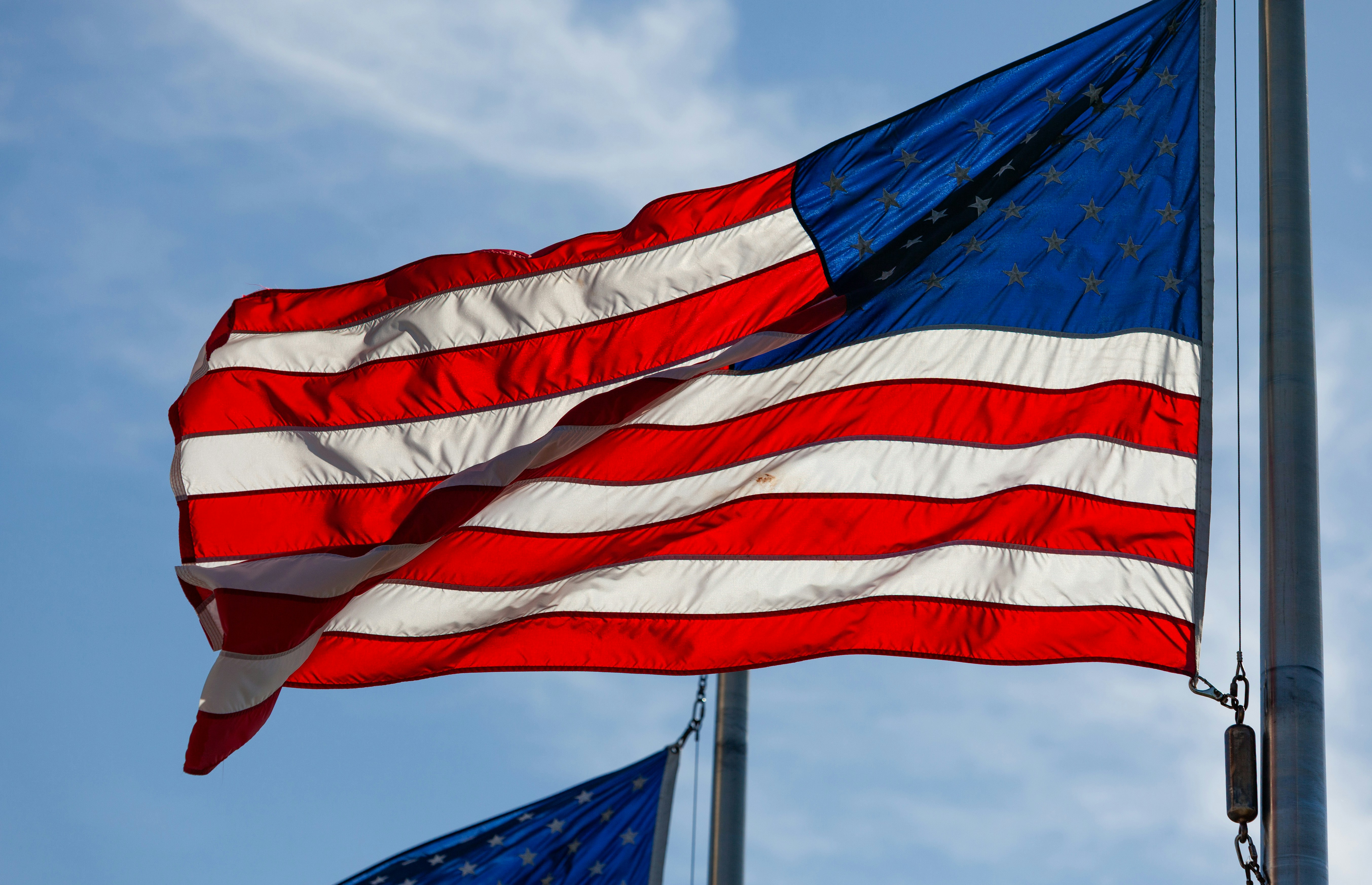 Waving Emblem: The American Flag in the Breeze Against a Clear Sky