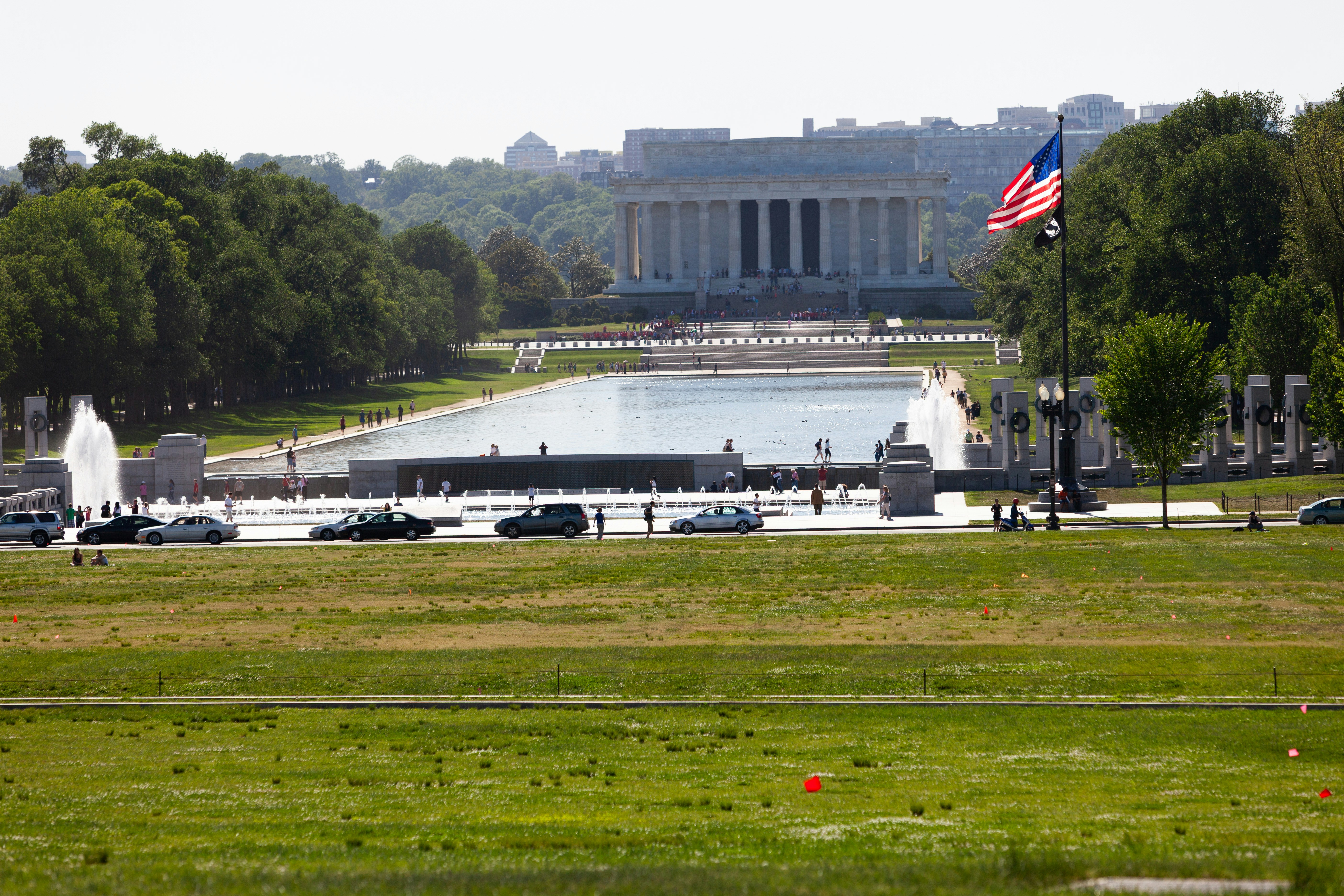 Monumental Reflective Pool Framed by Flag and Lincoln Memorial Temple
