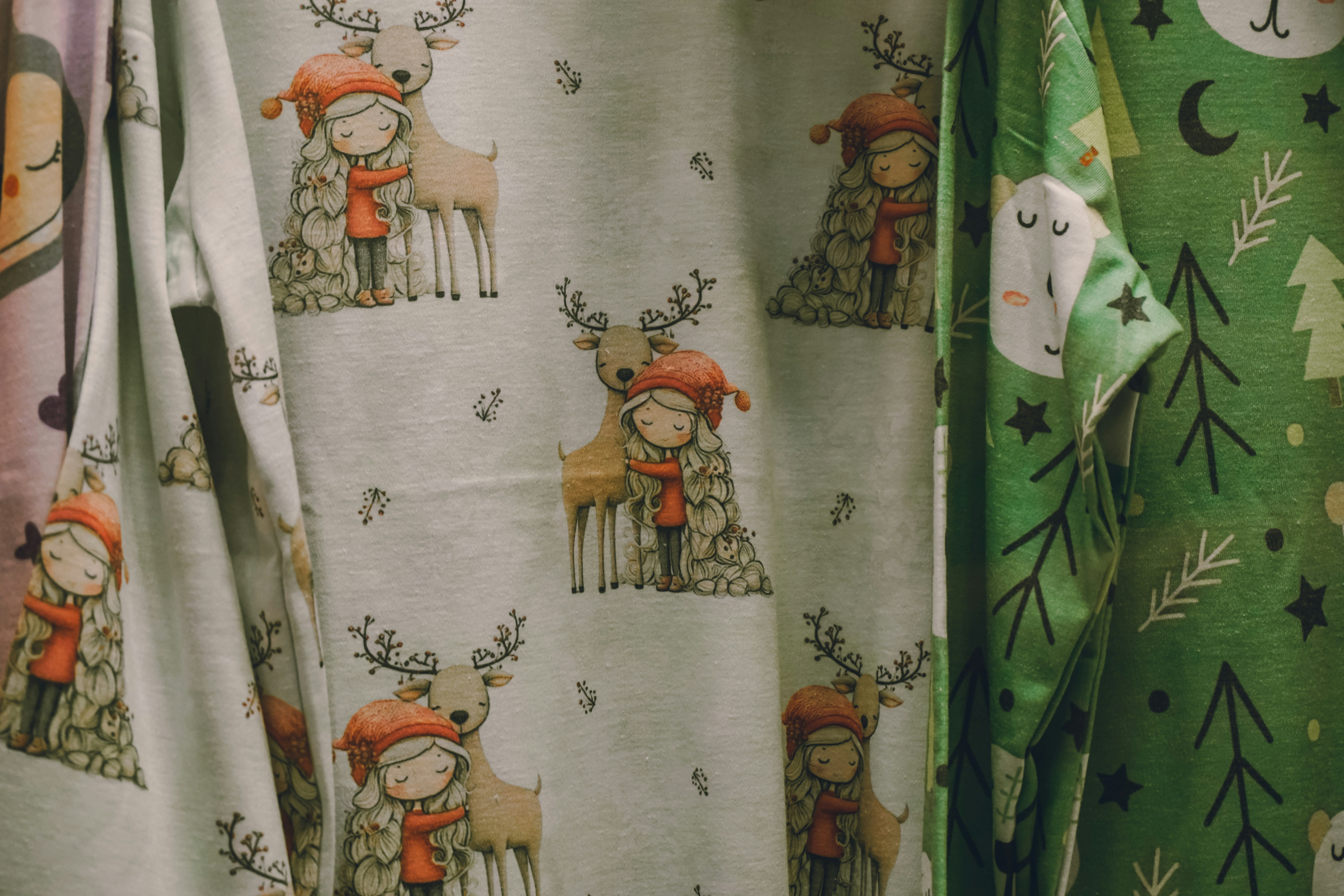 Winter garlands: A row of festive patterned fabrics with reindeer and forest motifs
