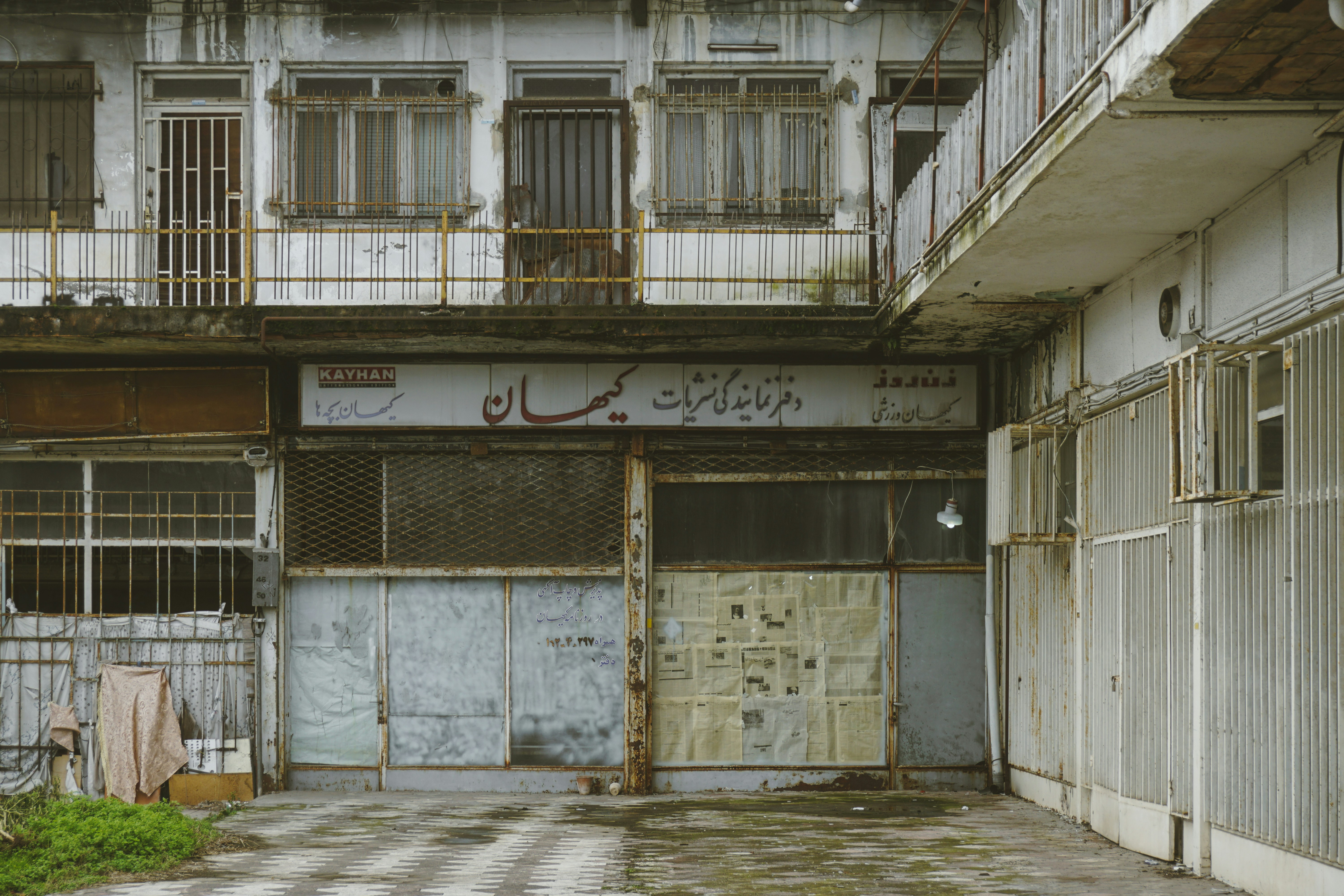 Abandoned storefronts Under a Weathered Balcony