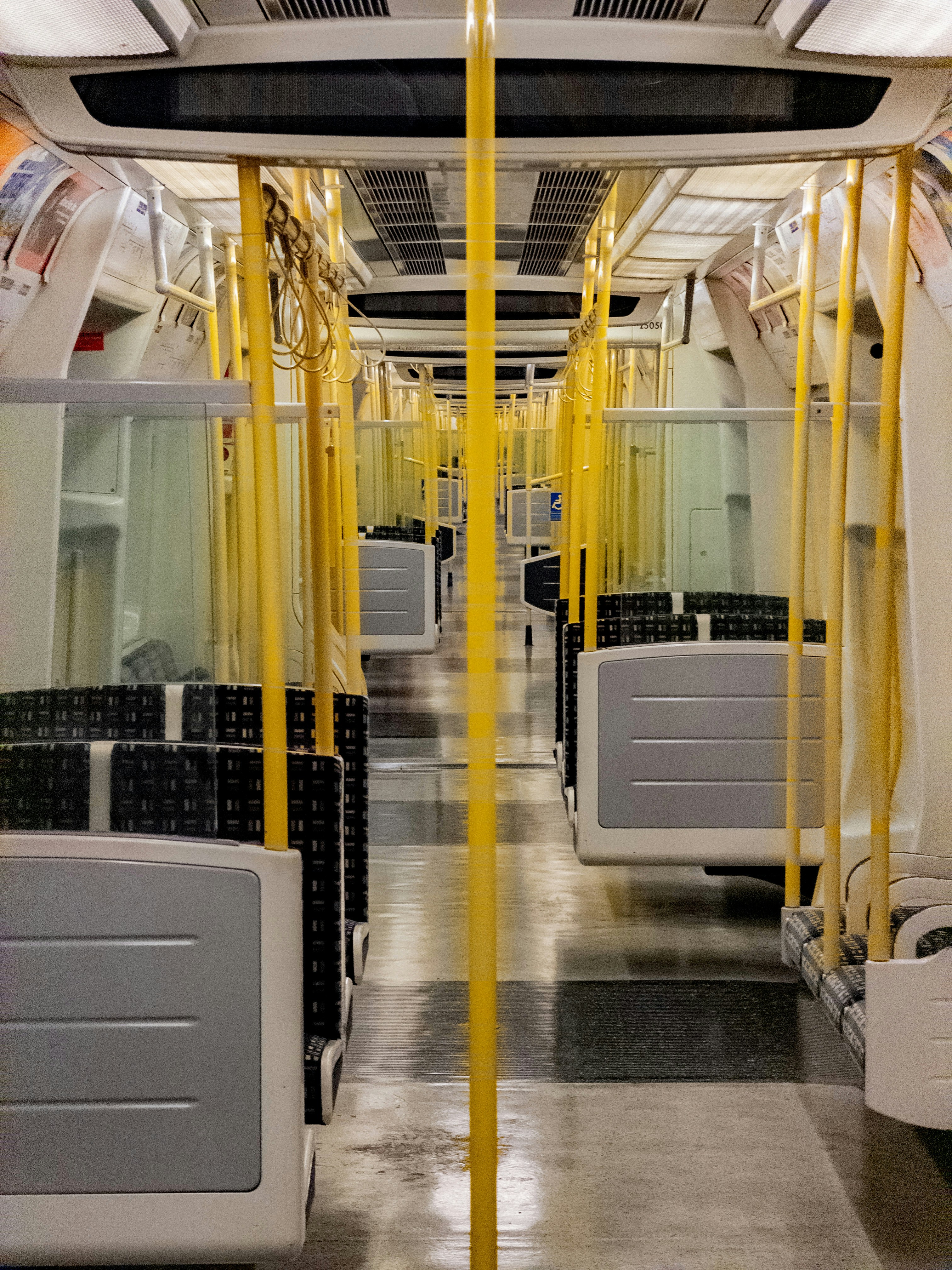 Yellow Poles and Empty Aisle: Quiet Transit
