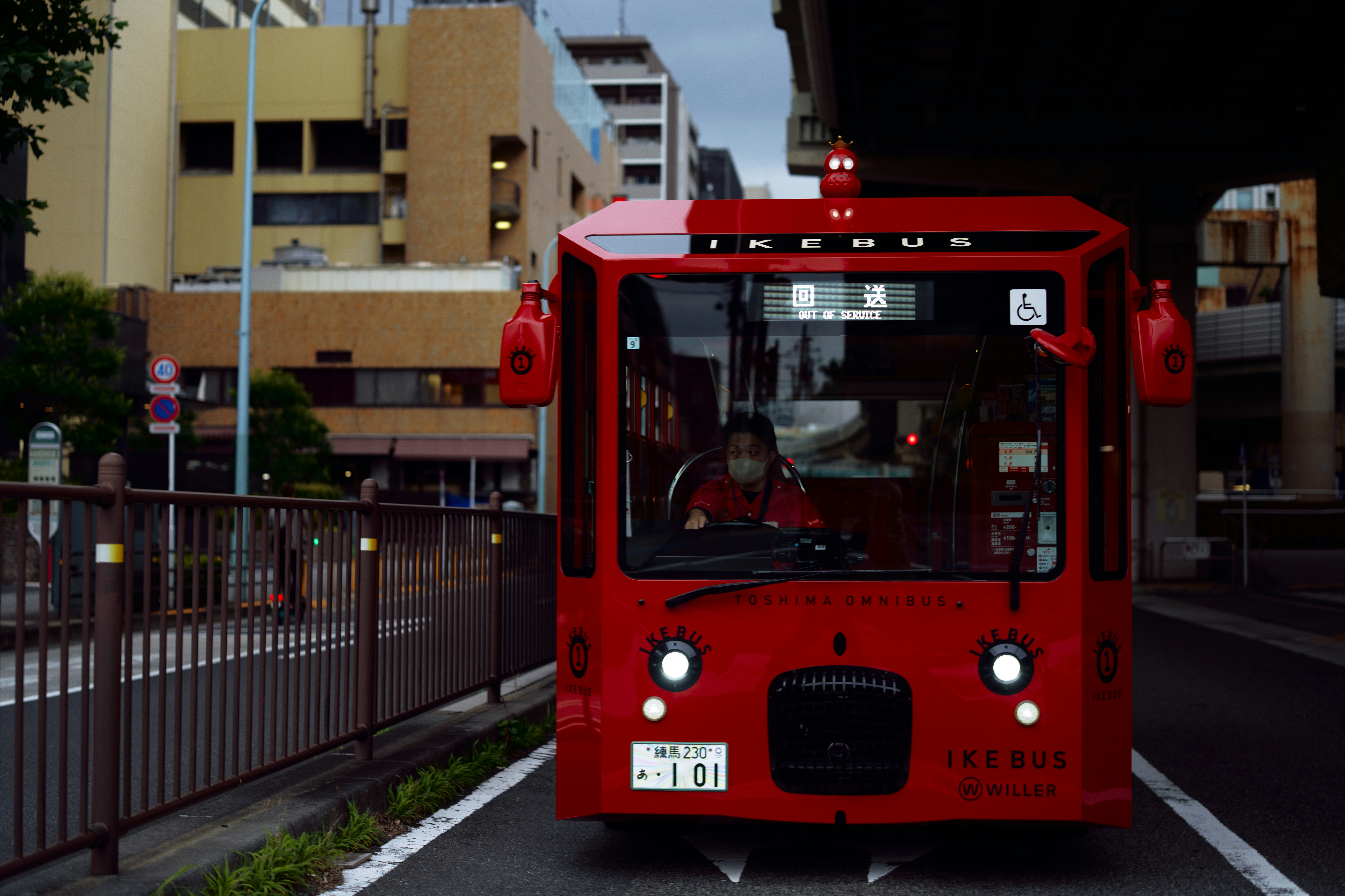 Red City Bus at an Urban Crossing