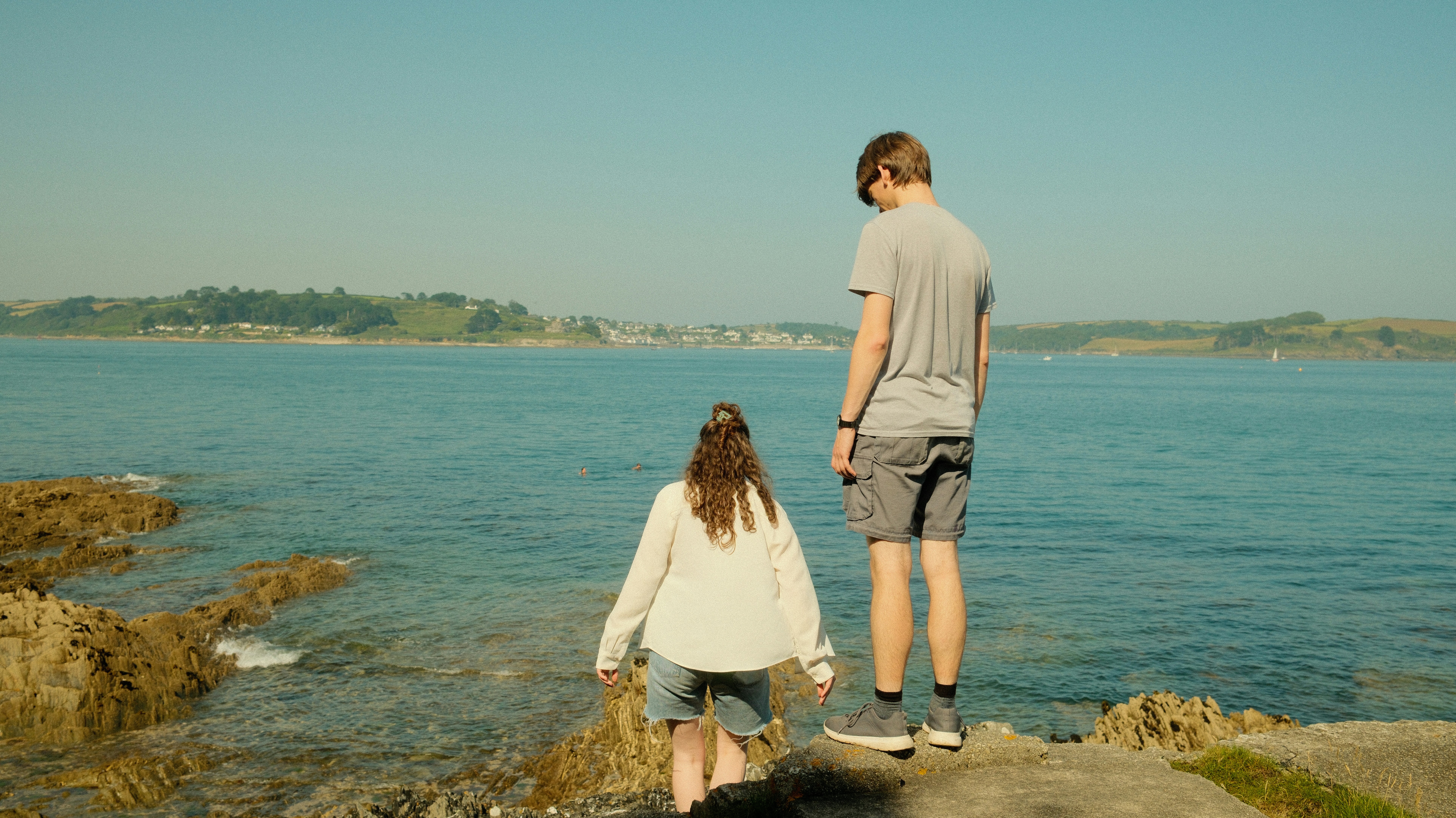 Two Figures at the Edge: Quiet Shoreline Moment
