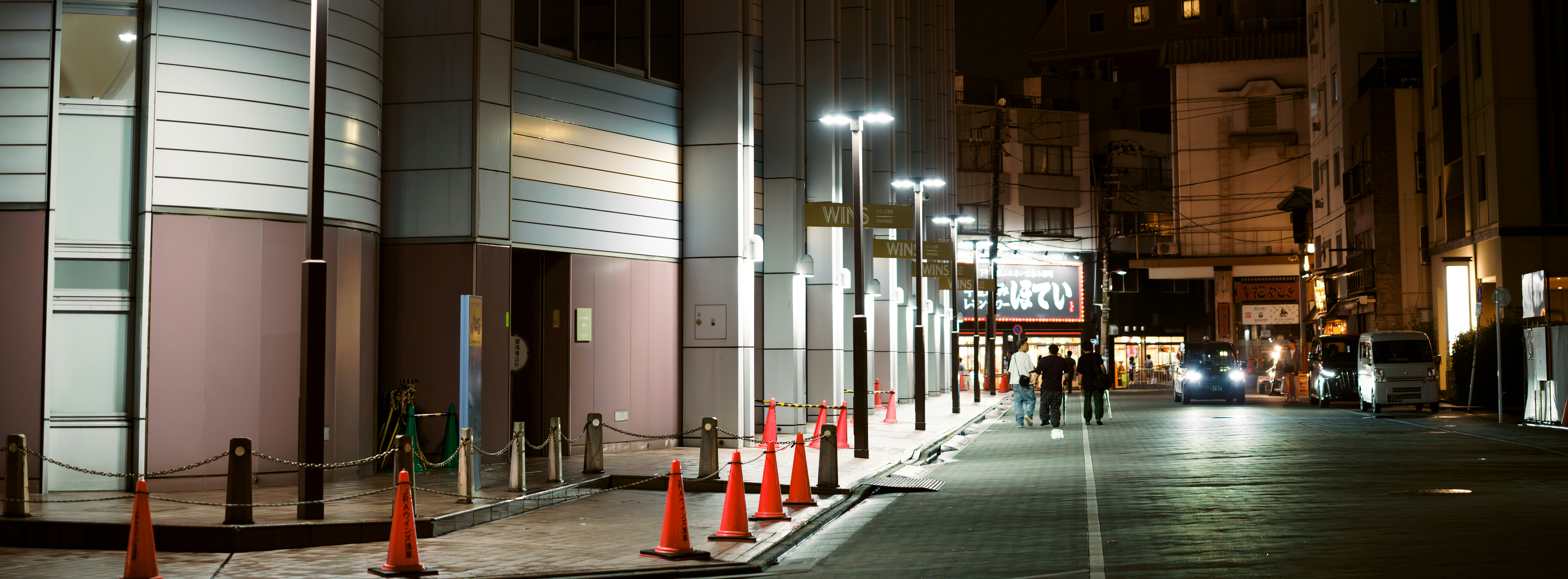 Quiet Night Shift: Street Lights, Cones, and Neon Signs