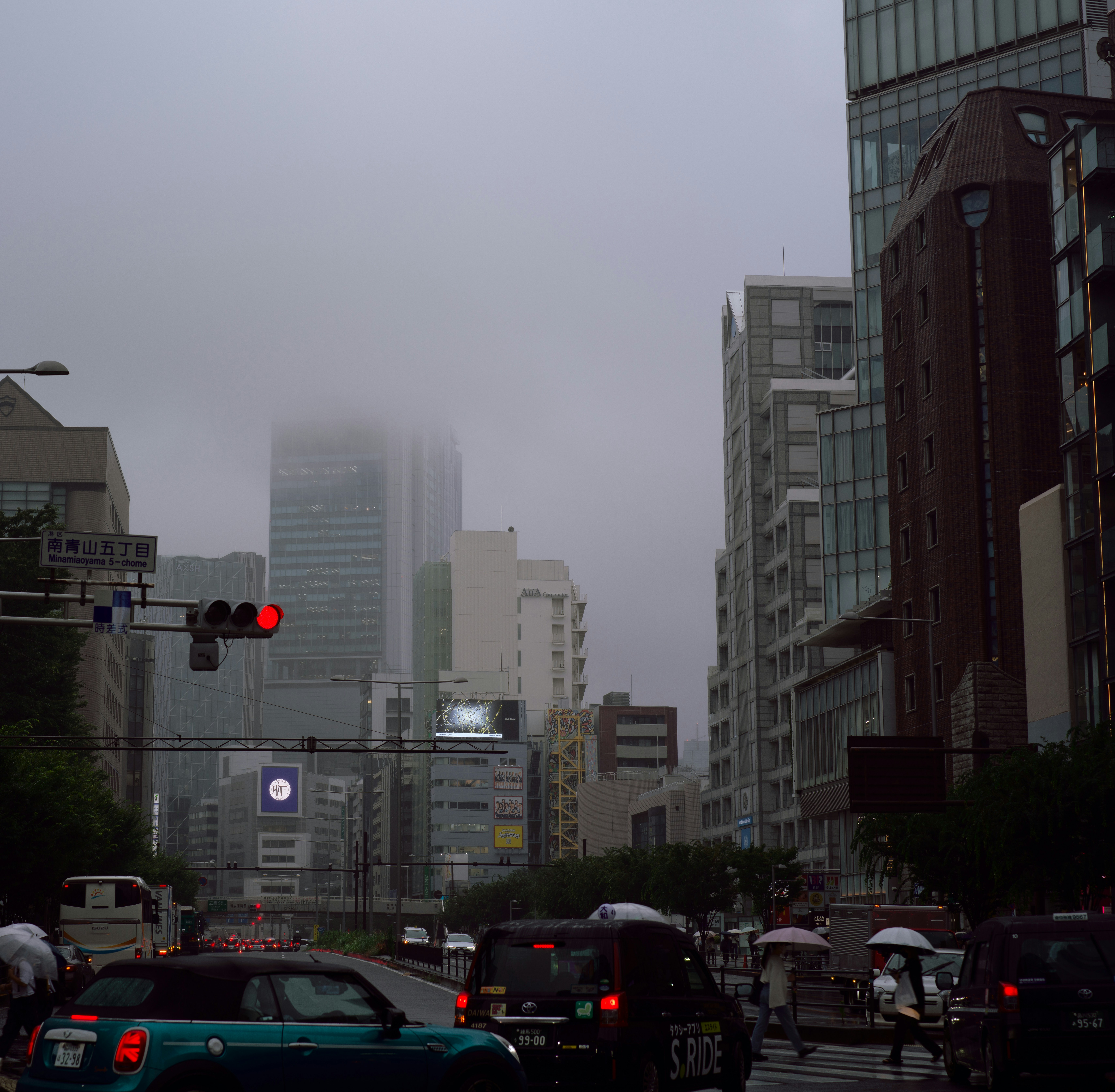 Morning Drift: Fogstruck Skyline over a Bustling City Street