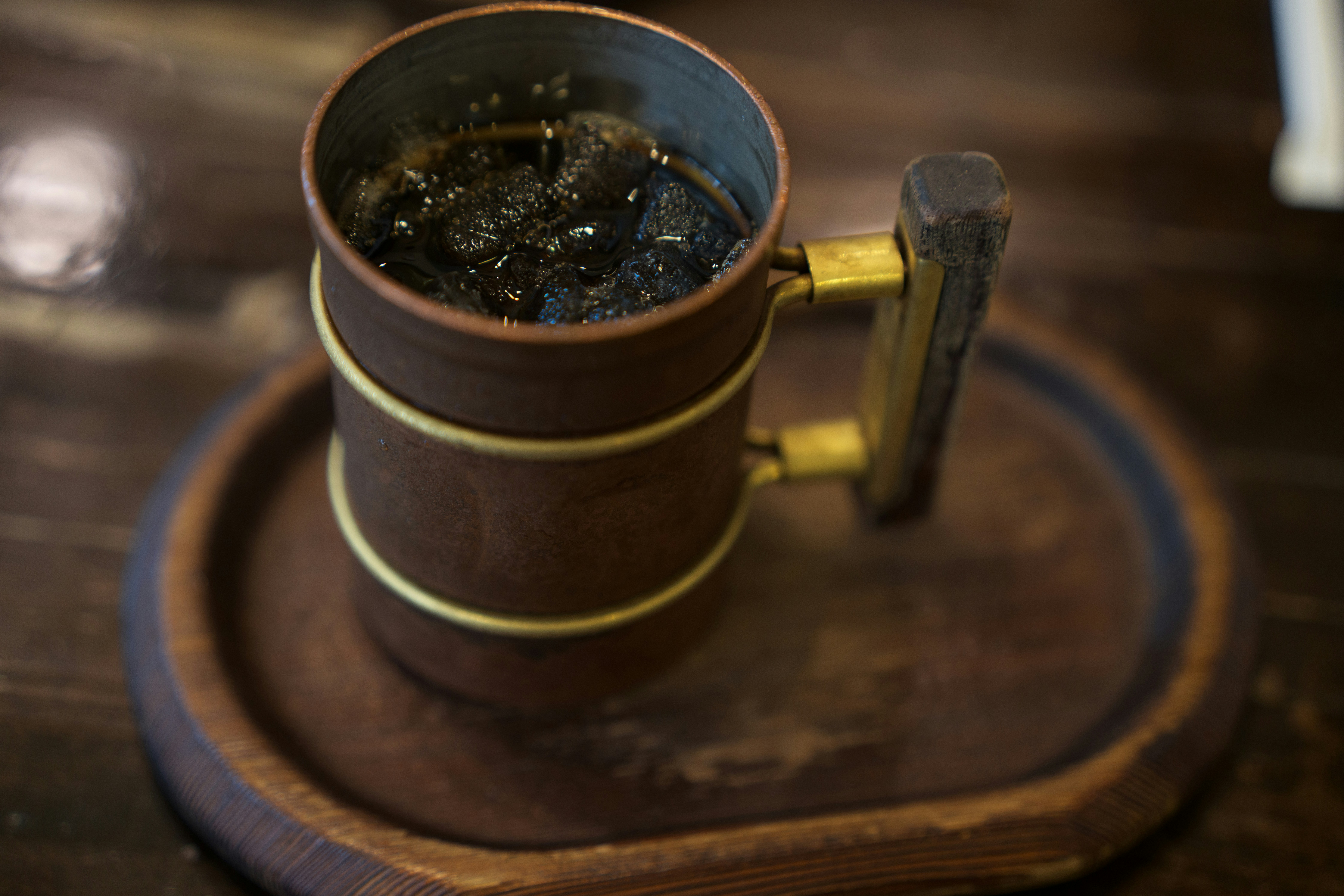 Copper Cup of Midnight Coffee on a Wooden Serve Tray