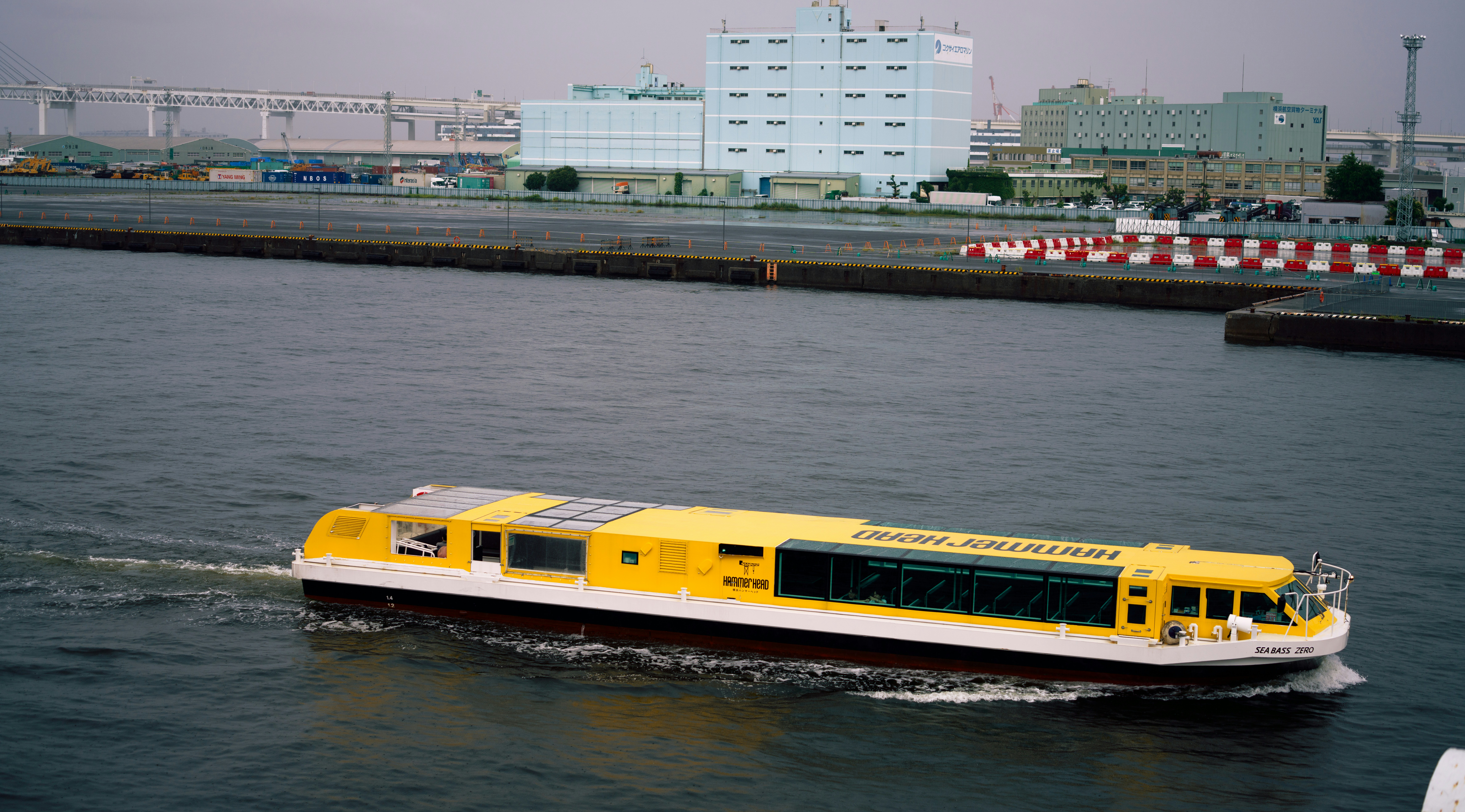 Yellow Water Taxi Slicing Through Harbor Light