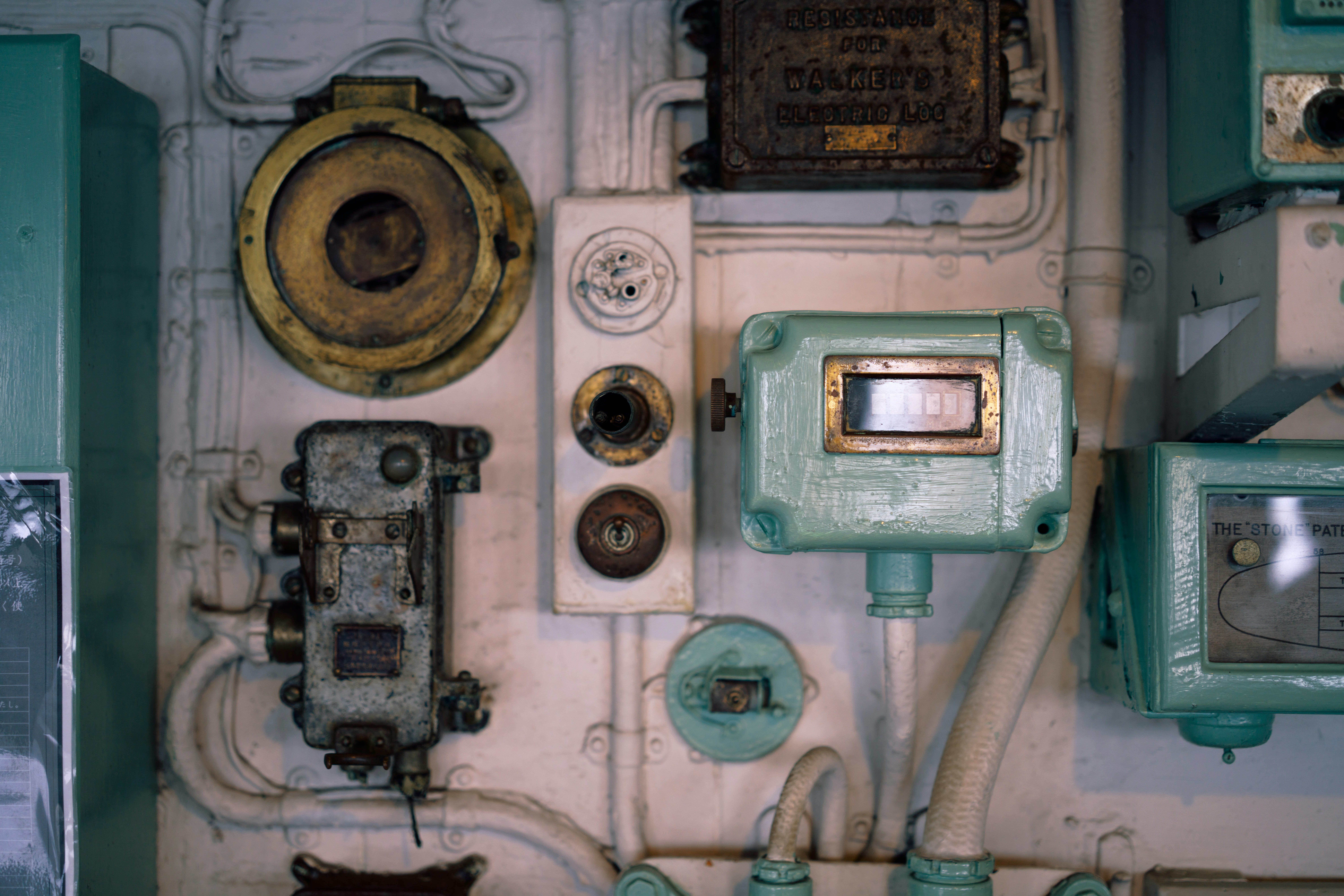 Industrial Conduits and Vintage Meters: A Teal-Tinted Machinery Wall