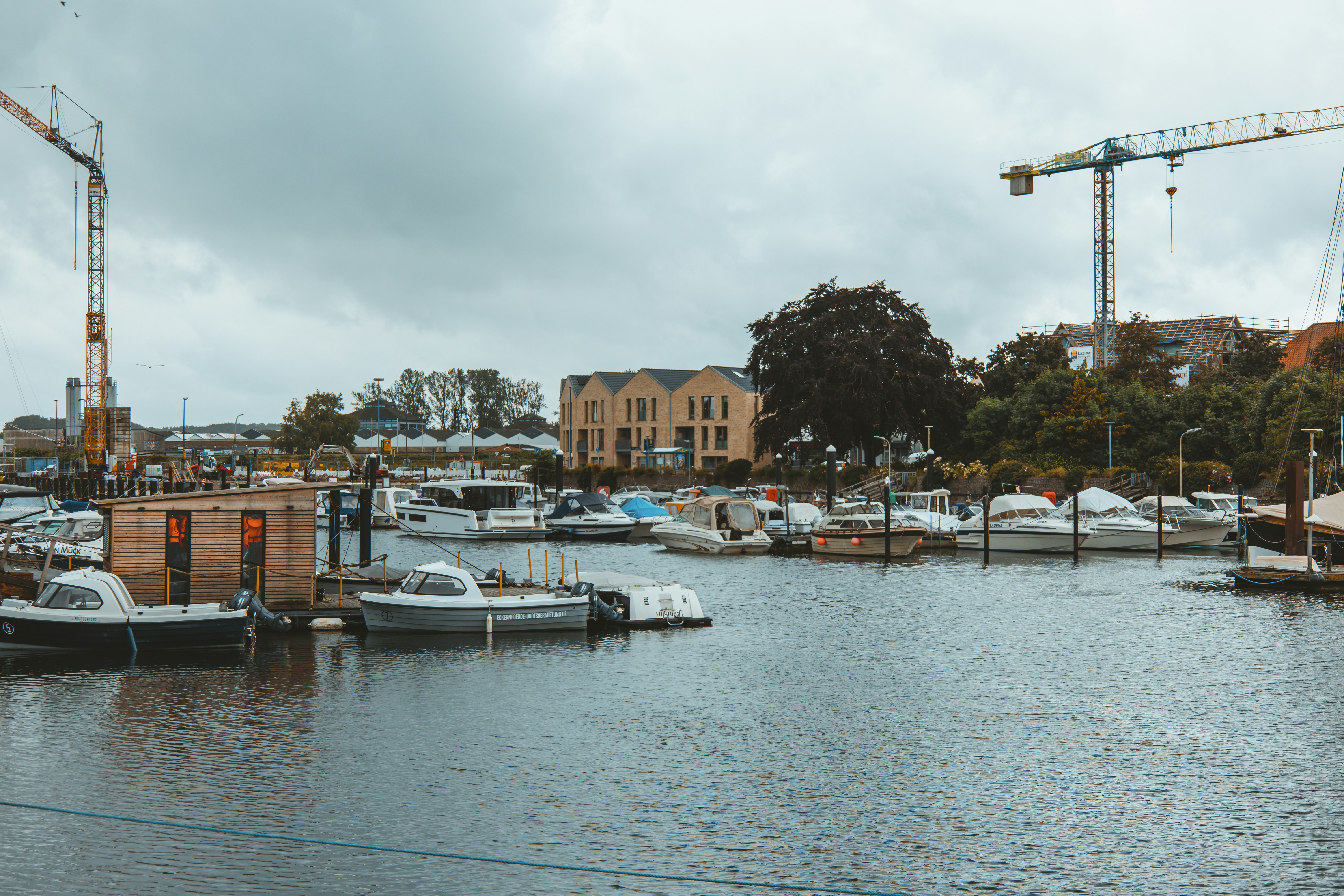 Marina Crest: Boats, Buildings, and Crane Silence