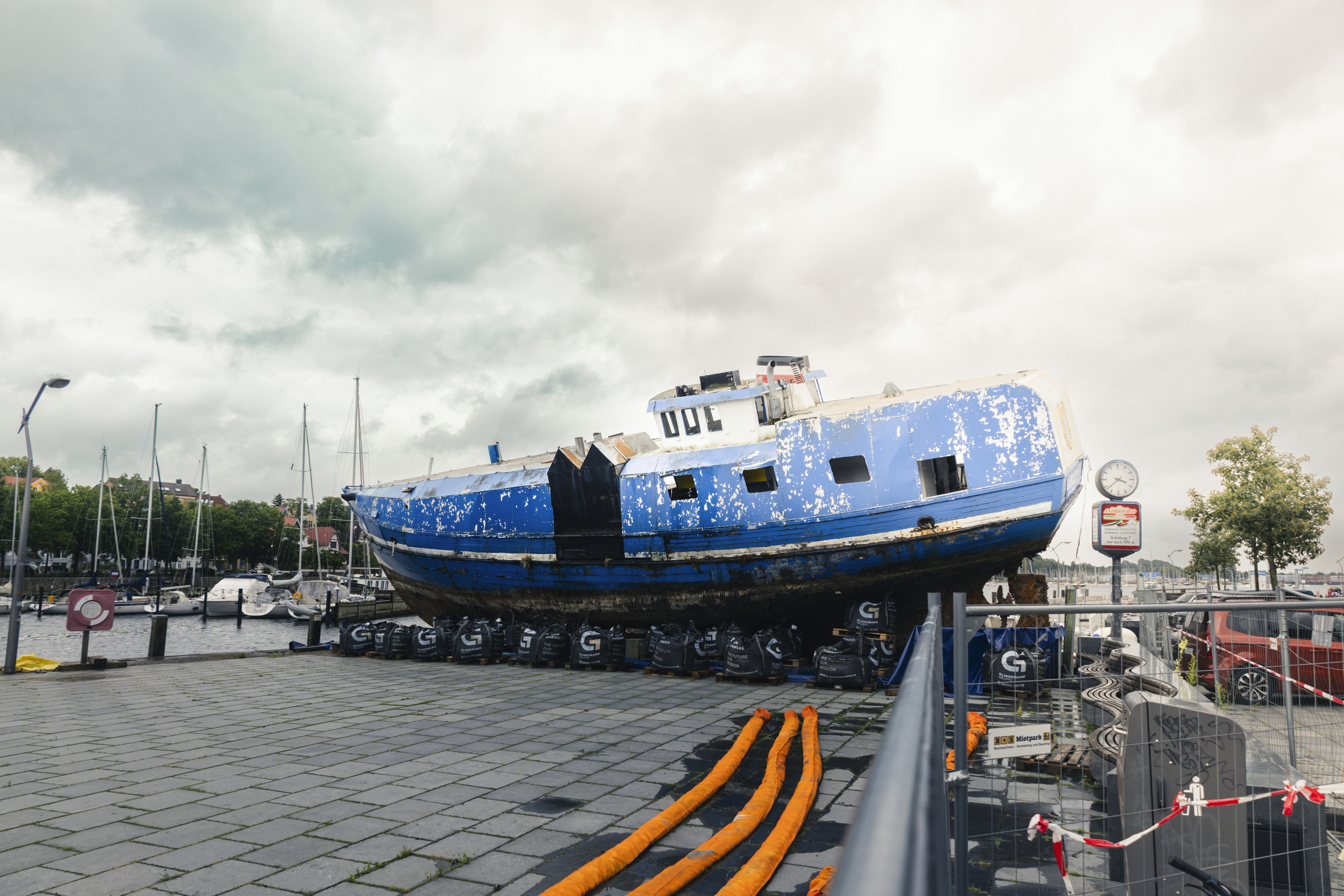 Blue Harbor Boat Lifted on Dry Dock by Chequered Waterfront