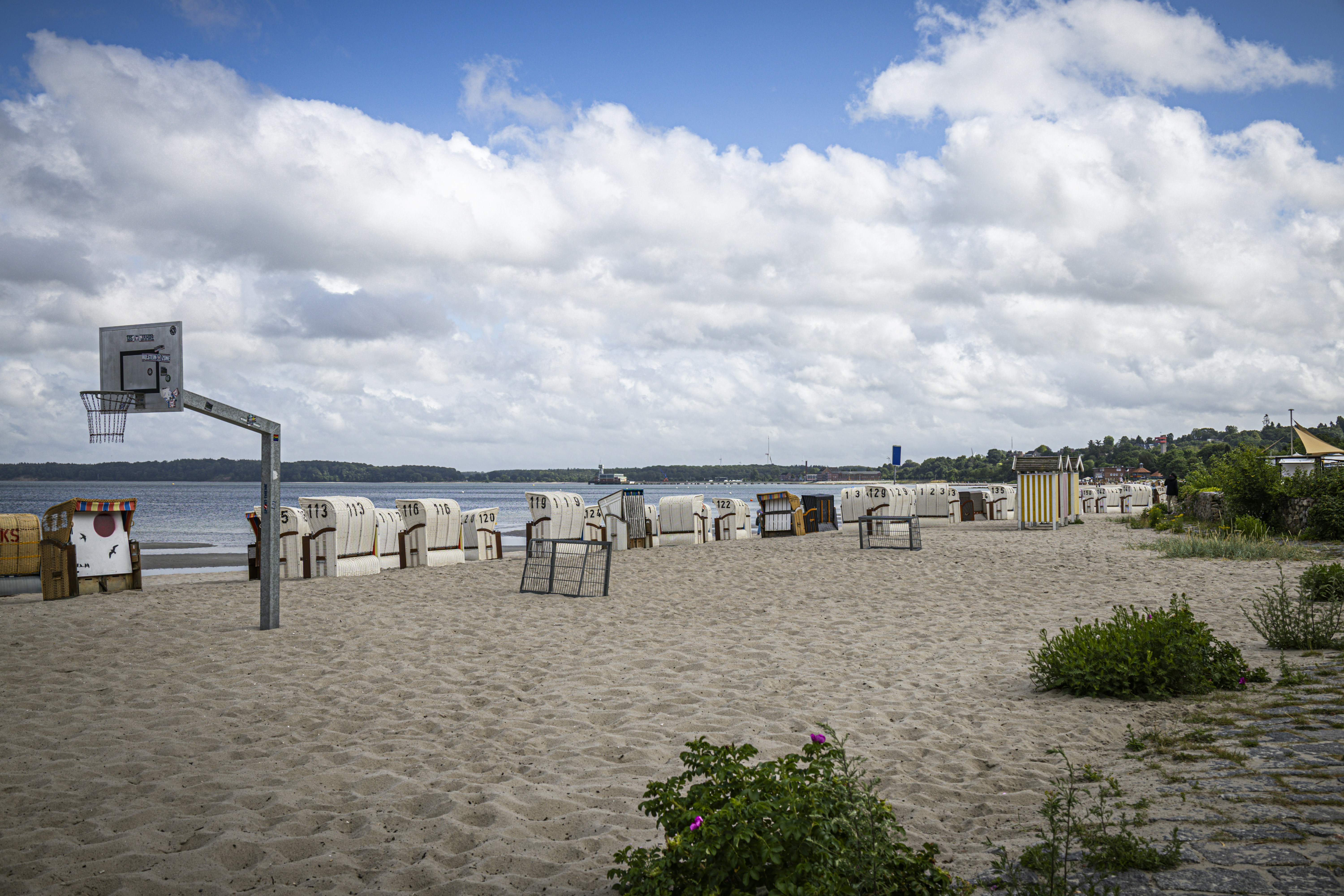 Coastline Court: Beachside Nets and Shade on a Sunny Day
