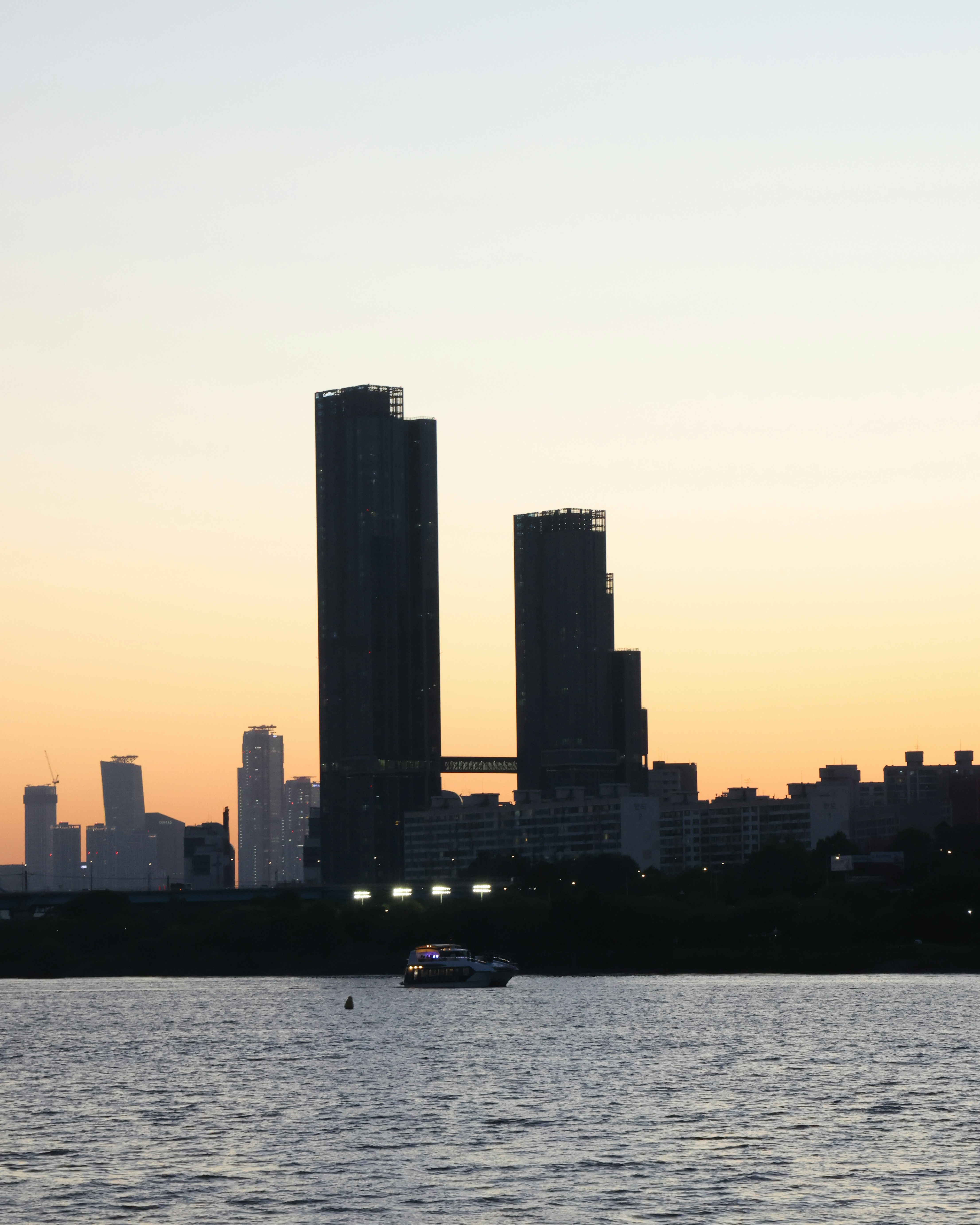 Sunset Silhouette Over a Quiet City Waterfront