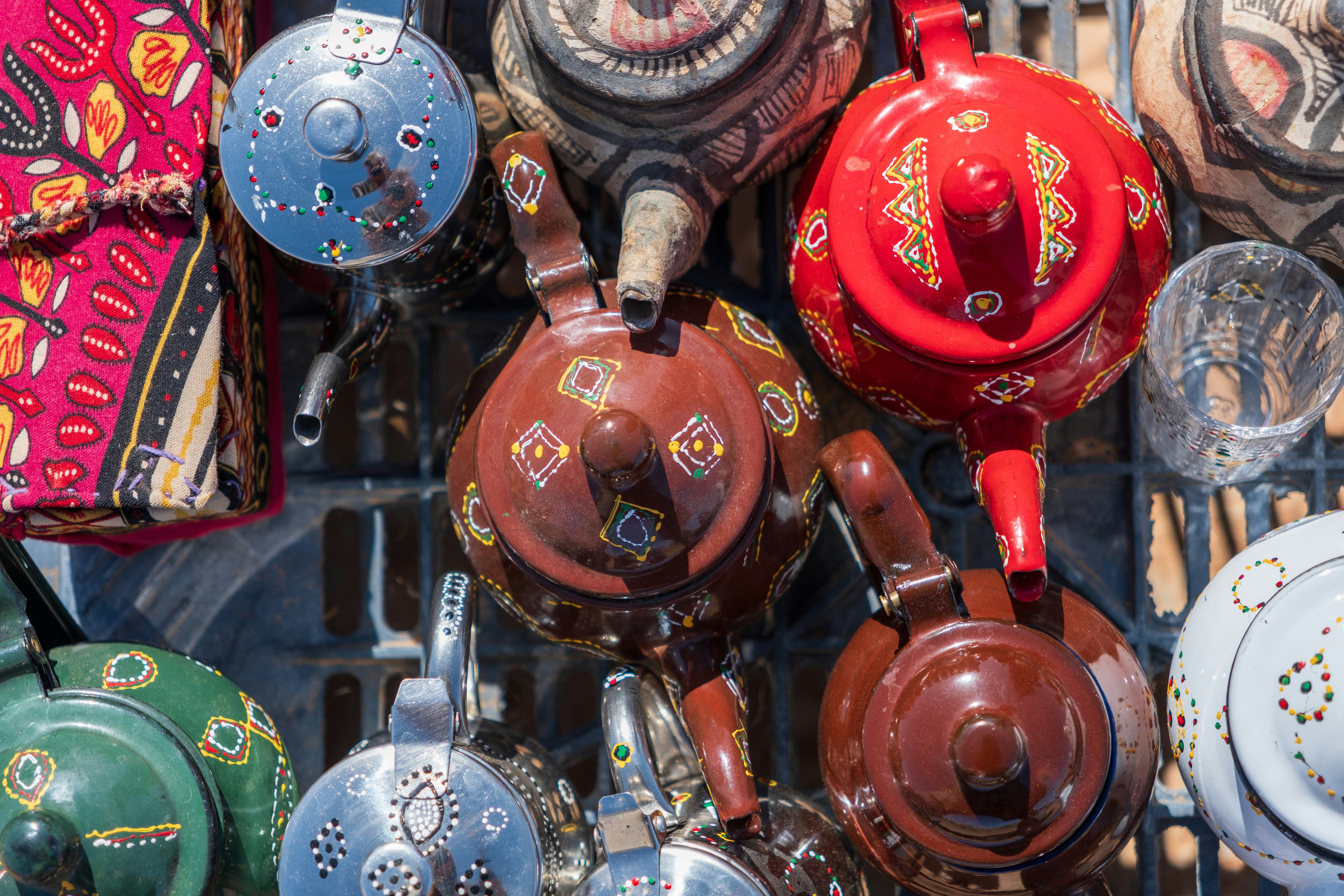 Colorful Teapot Parade Under Glass