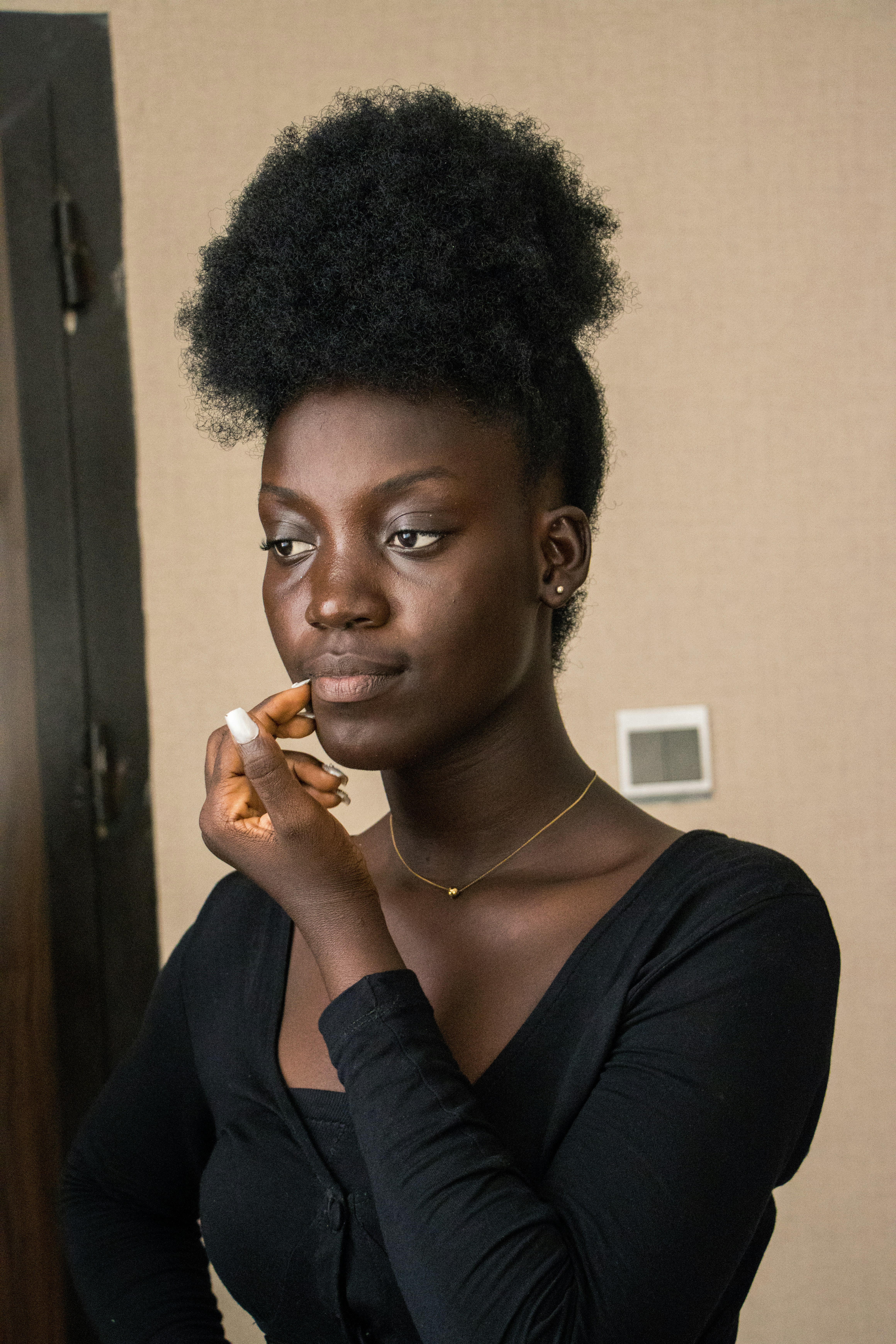 Quiet Contemplation: Close-Up of a Woman Touching Her Lipstick