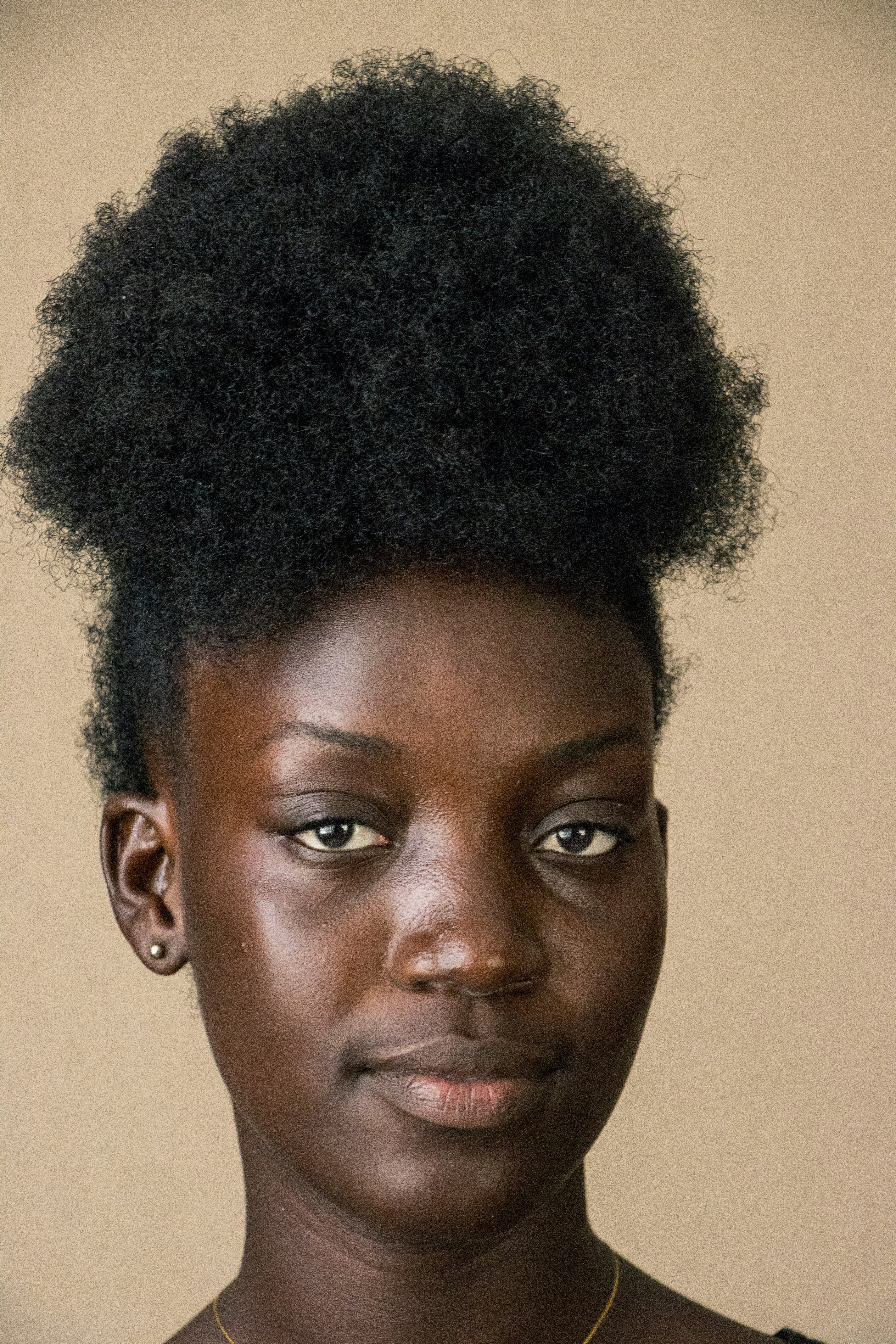 Tall Afro, Quiet Poise: Portrait of Focused Gaze